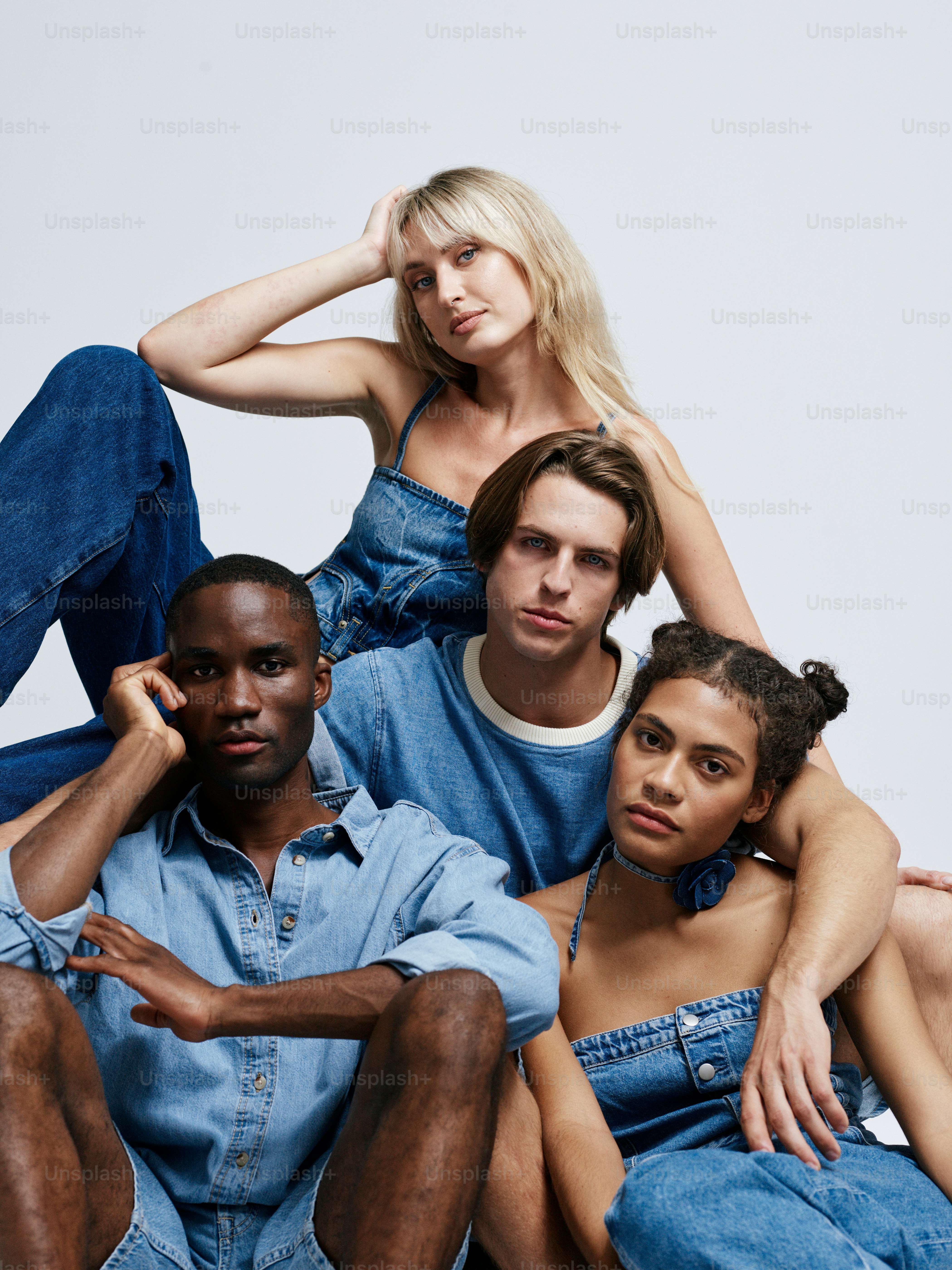 A group of people sitting next to each other photo – Studio Image on ...