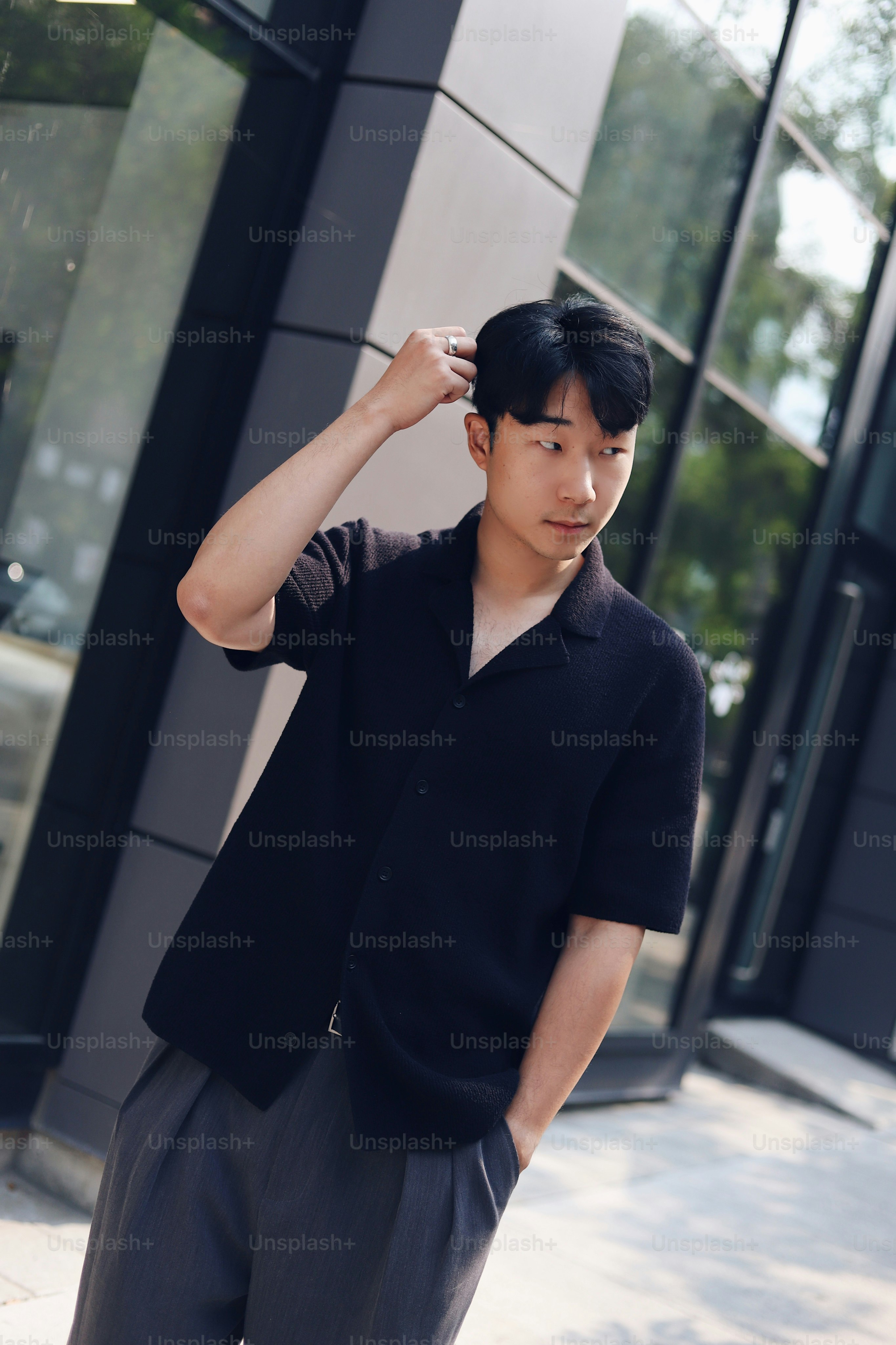 A man sitting on a bench holding a cell phone photo – Handsome man ...