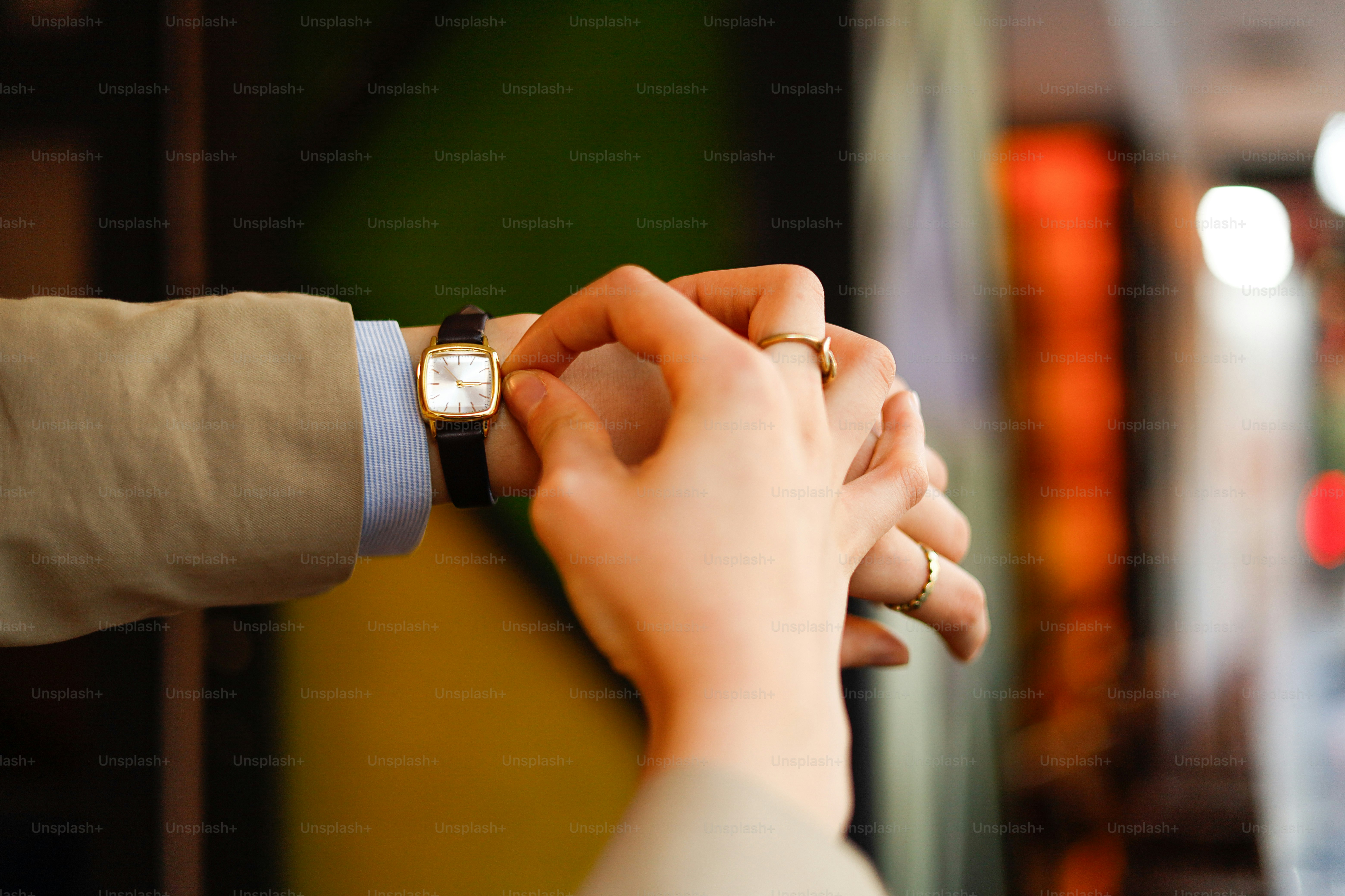 A couple of people that are holding hands photo – Watches Image on Unsplash