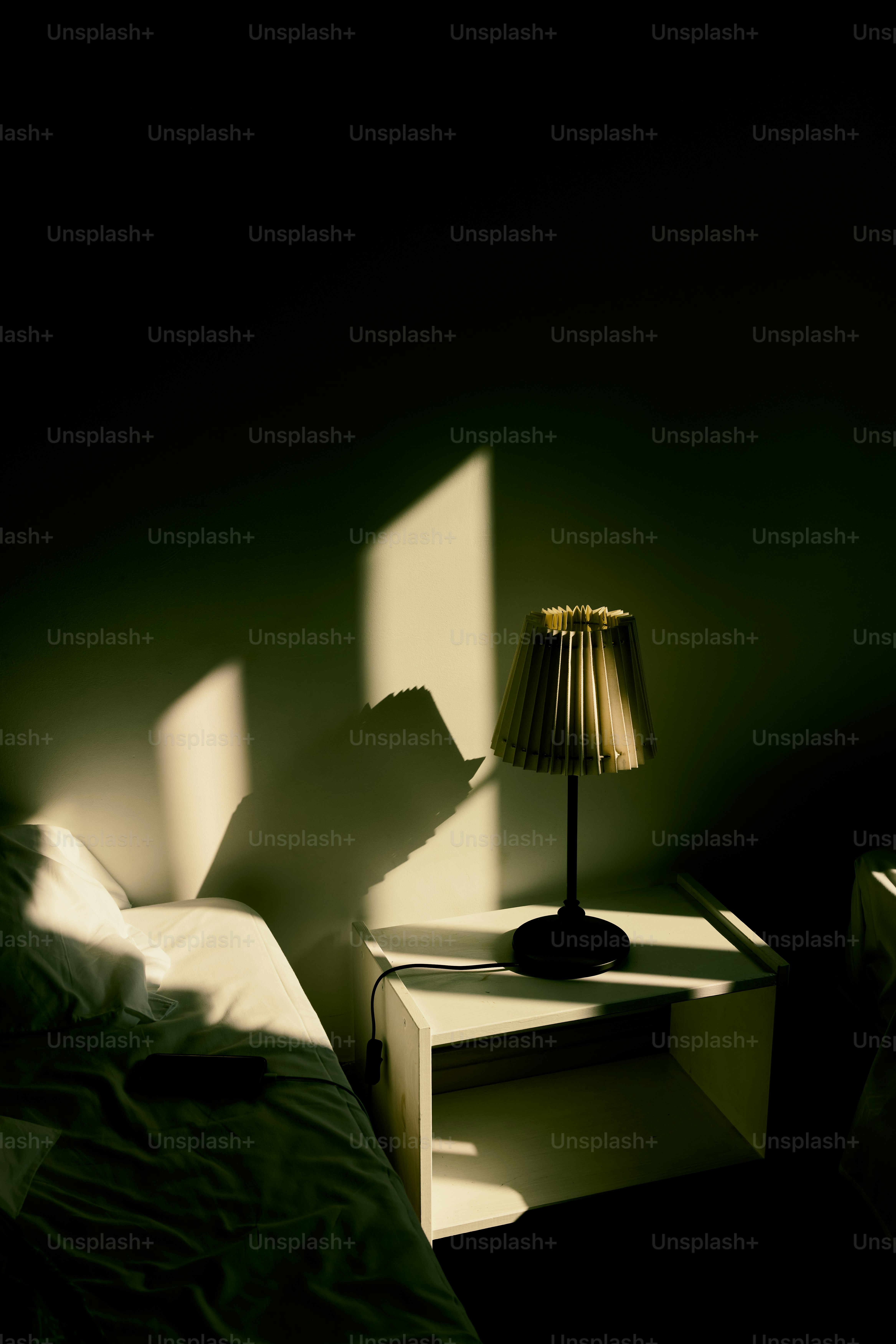 A lamp casts a shadow on the wall next to a bed photo – Dark aesthetic ...