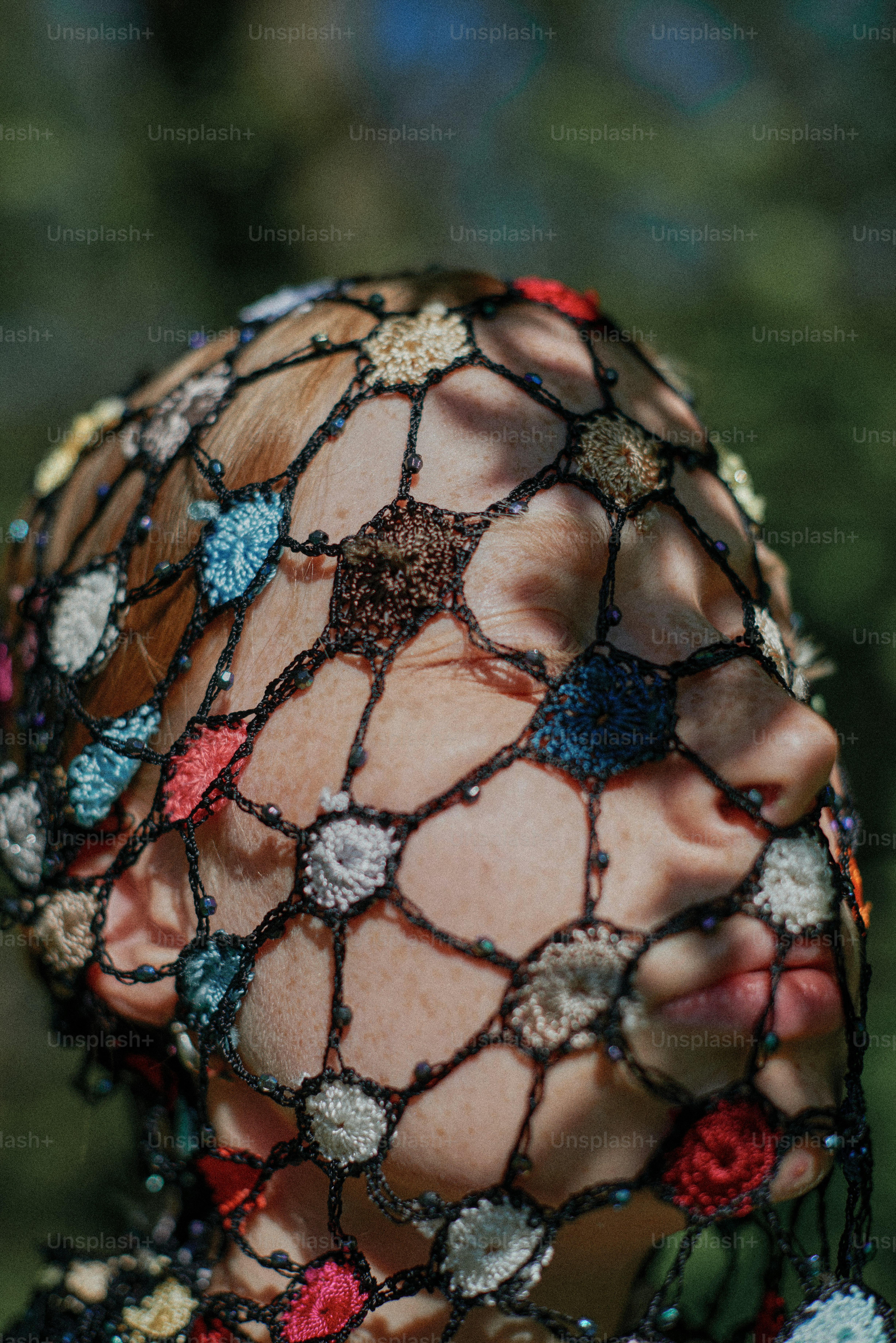 A close up of a person wearing a net headdress photo – Mental health ...