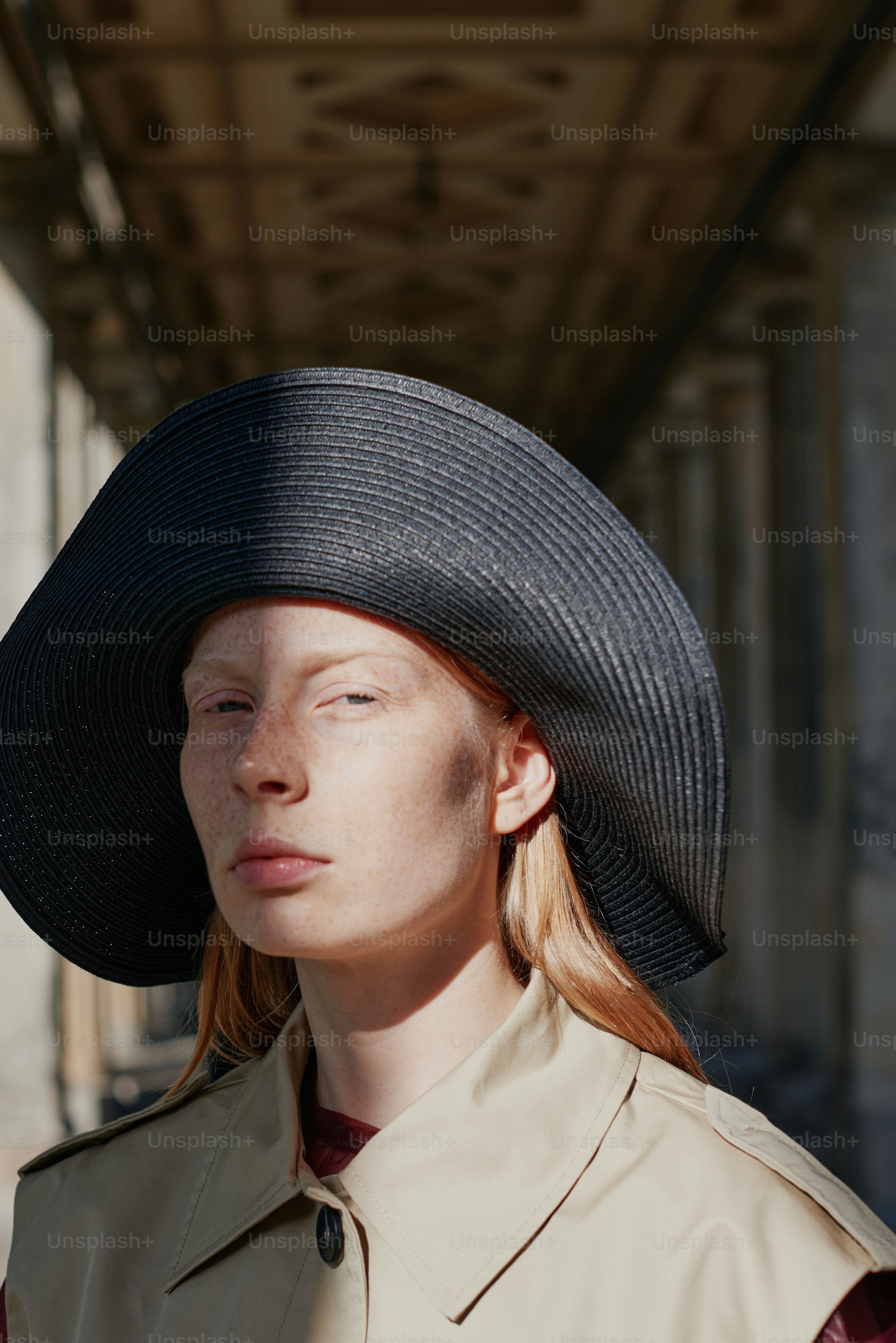 A woman wearing a large white hat on top of her head photo – Fashion ...