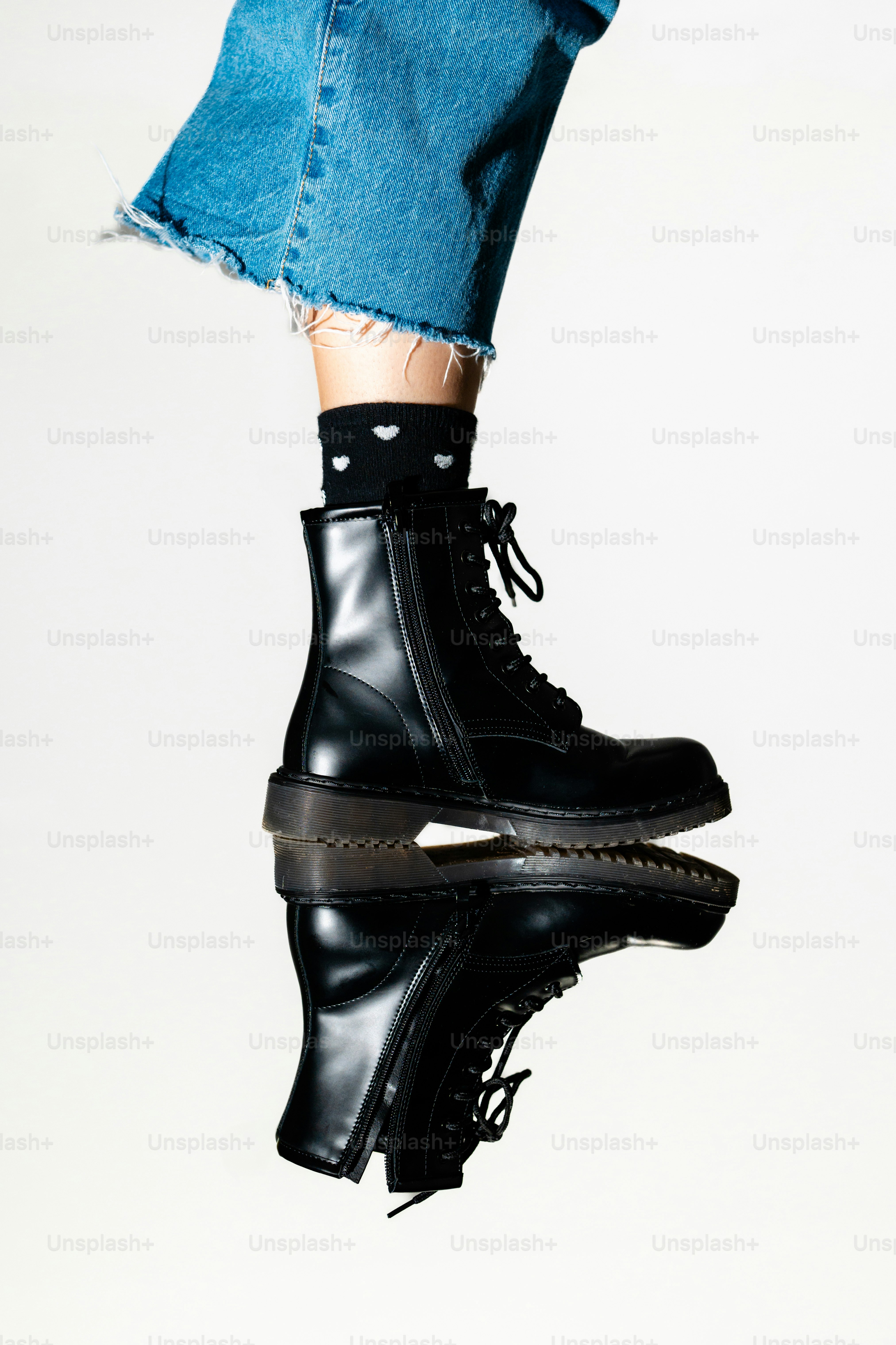 A woman's legs with a pair of black boots photo – Lace up boots Image ...