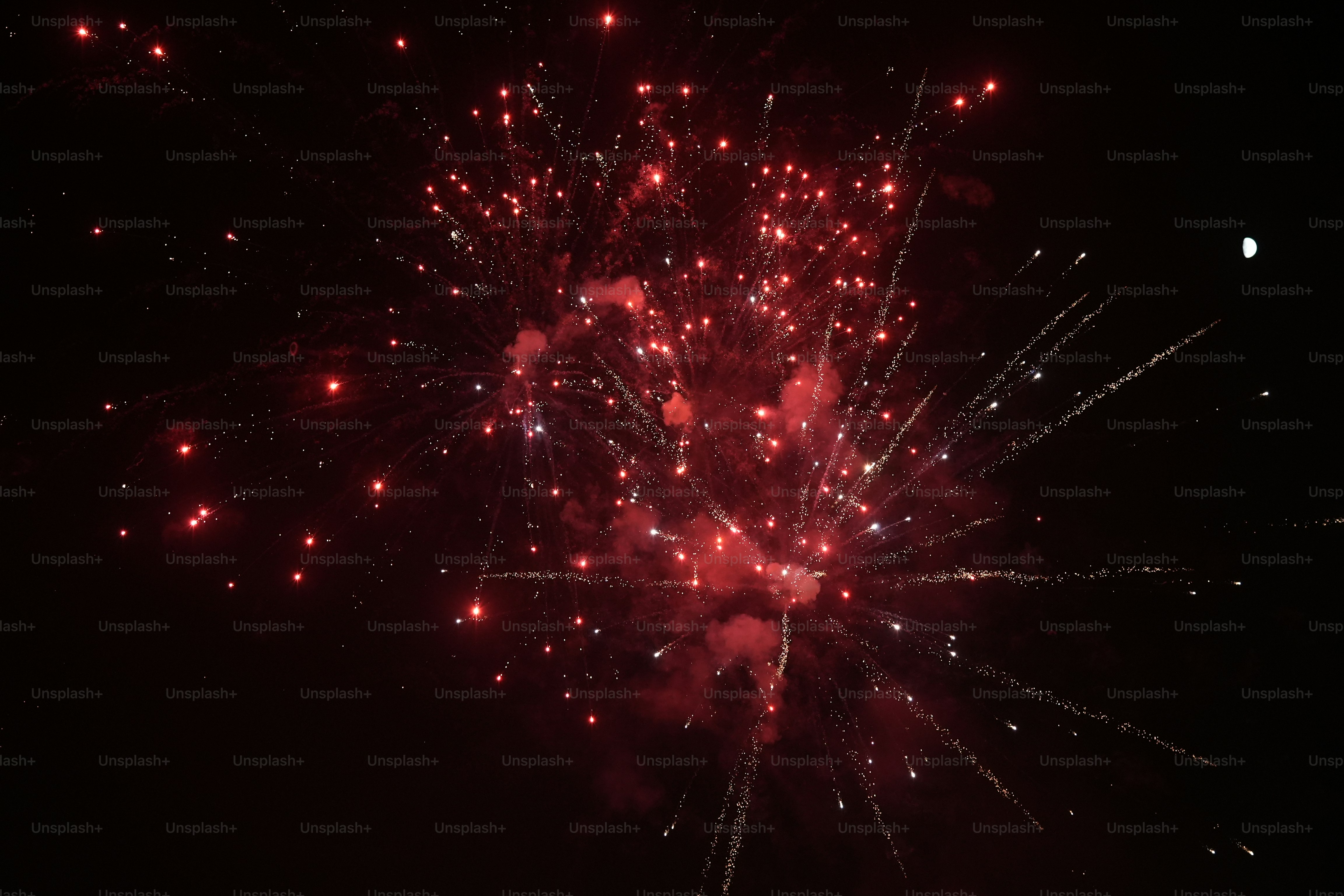 A red and white firework in the night sky photo – Sky Image on Unsplash