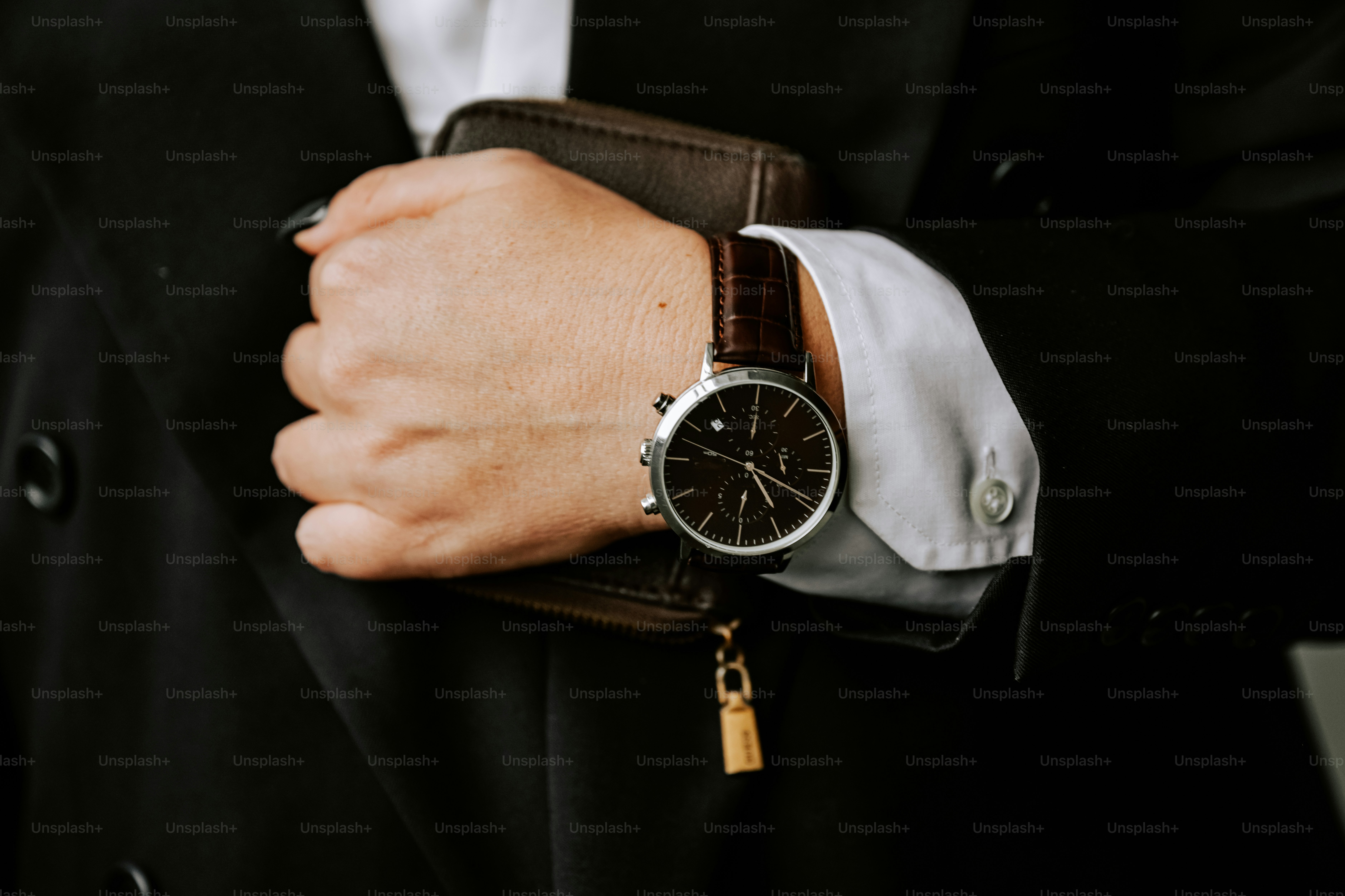 A man in a suit with a watch on his wrist photo – Timepiece Image on ...