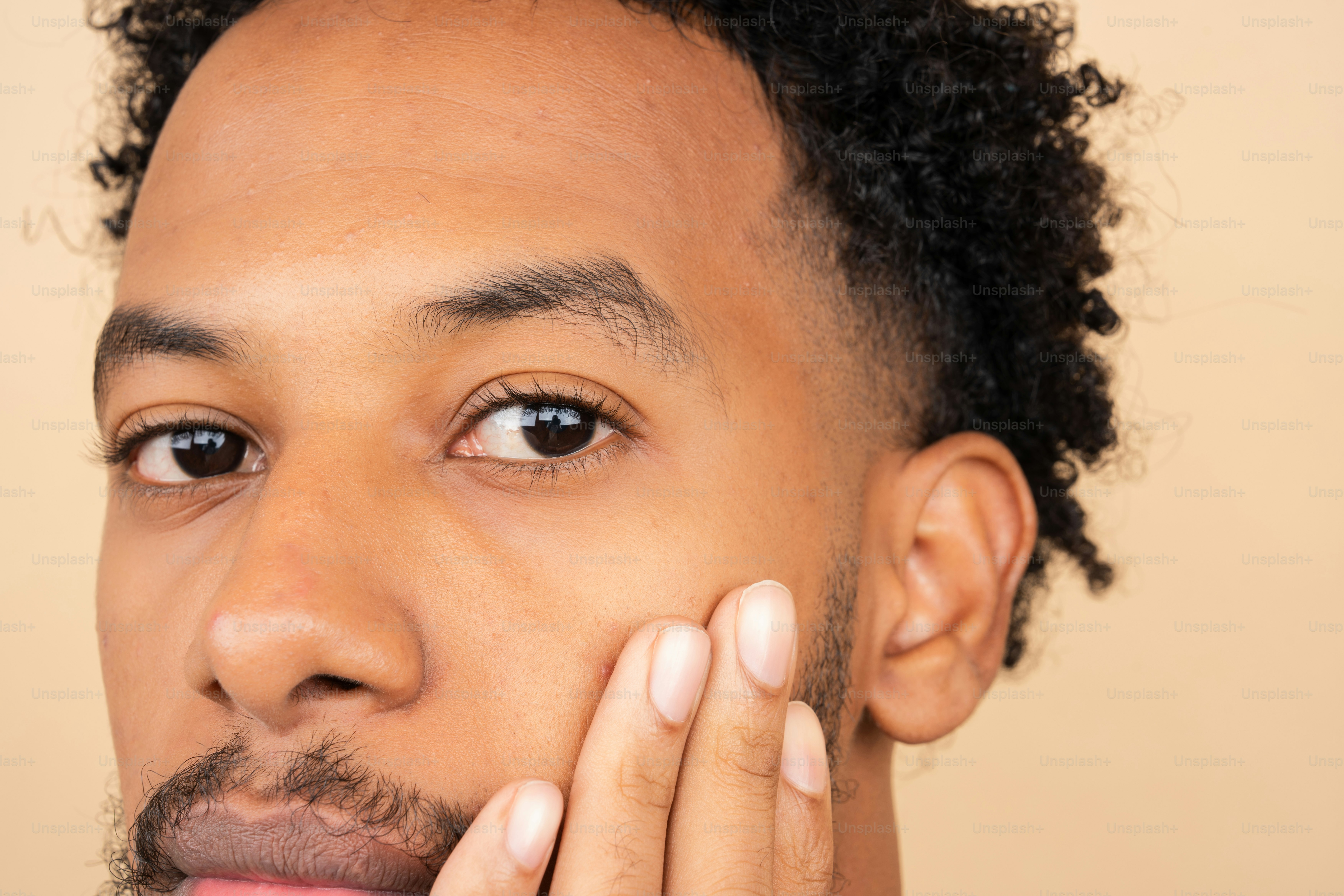 A close up of a person putting a cream on his face photo – Skin Image ...