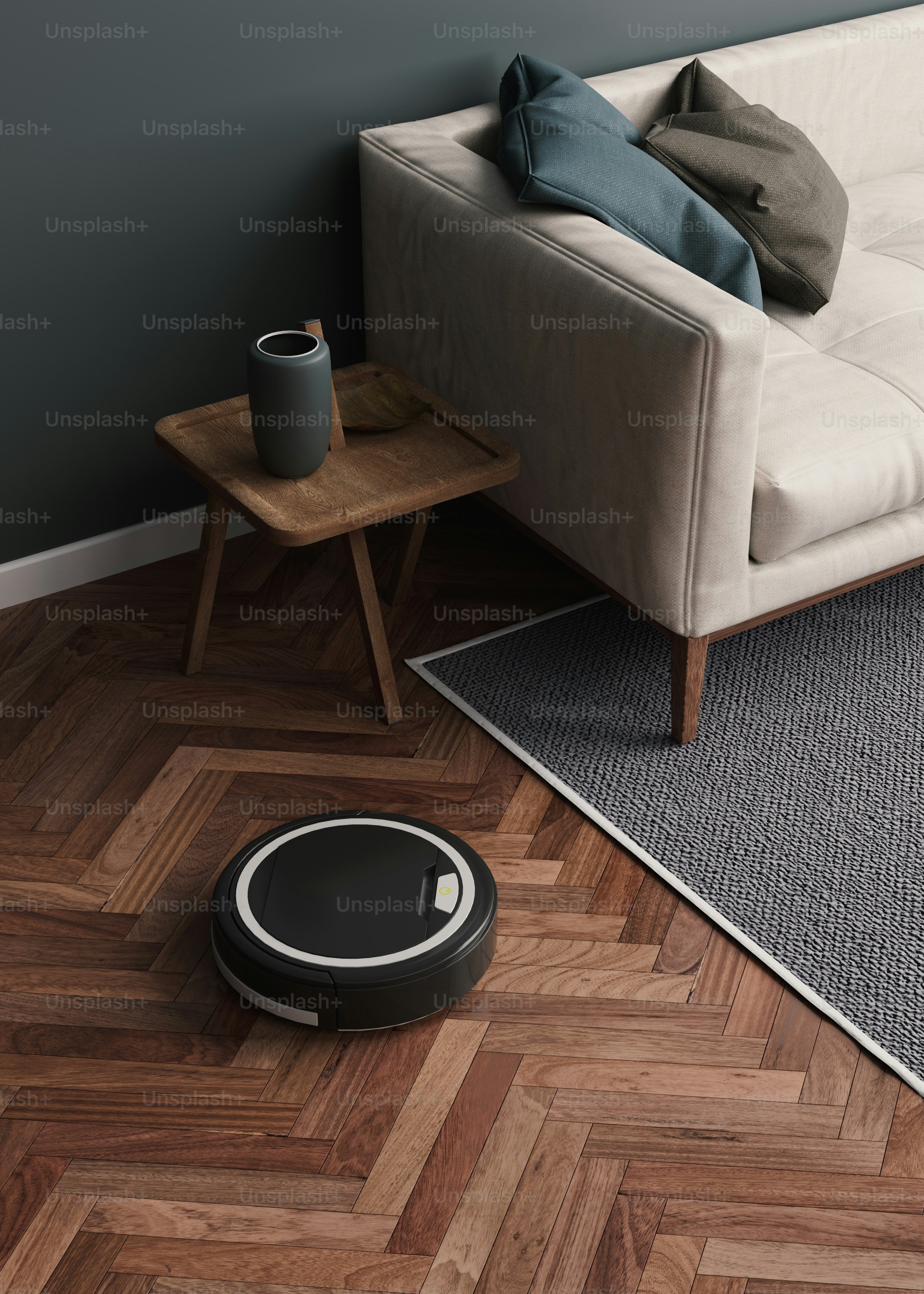 A living room with a couch and a robotic vacuum photo – Tech Image on ...