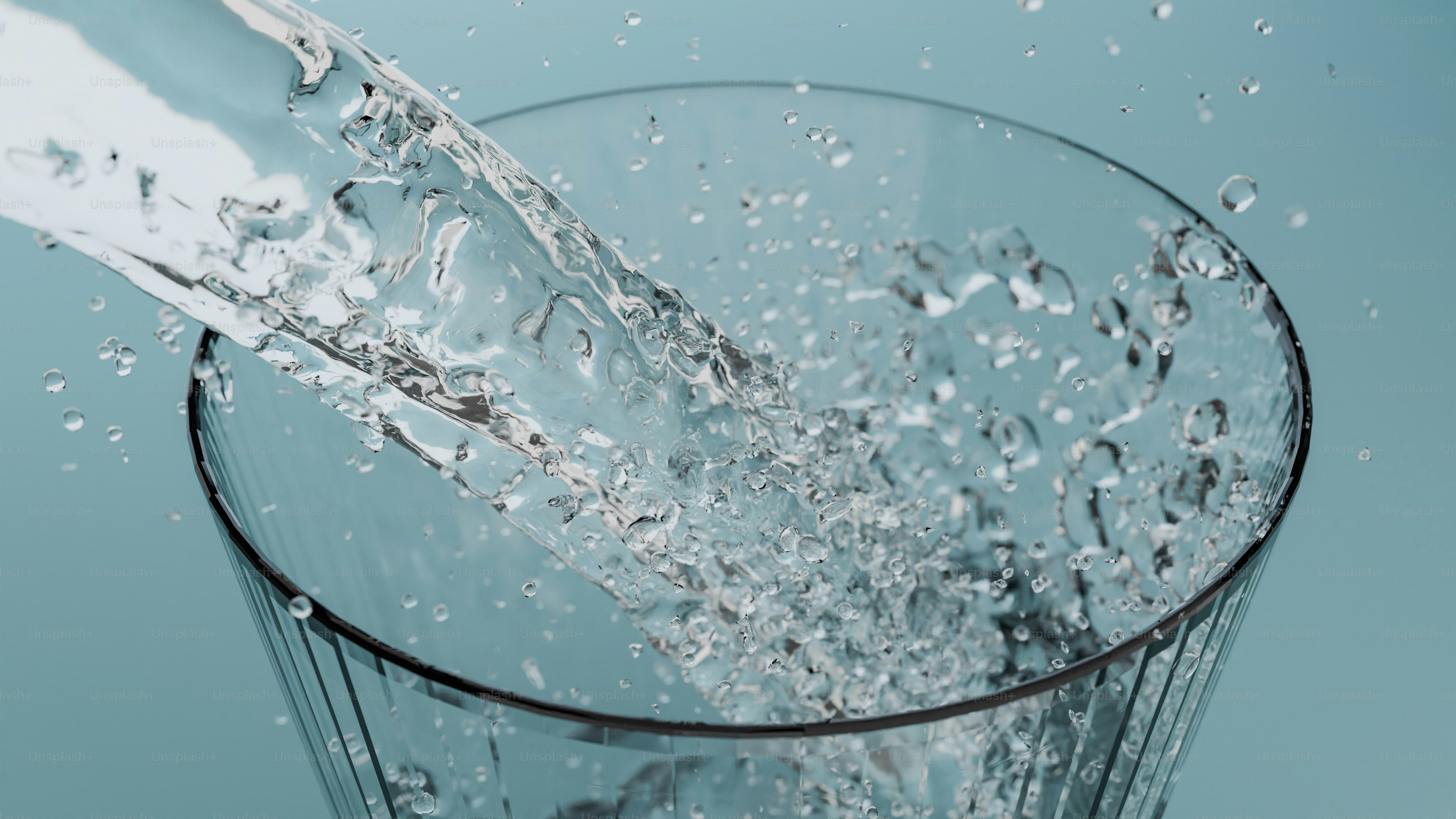 A glass filled with water on top of a table photo – Splash Image on ...