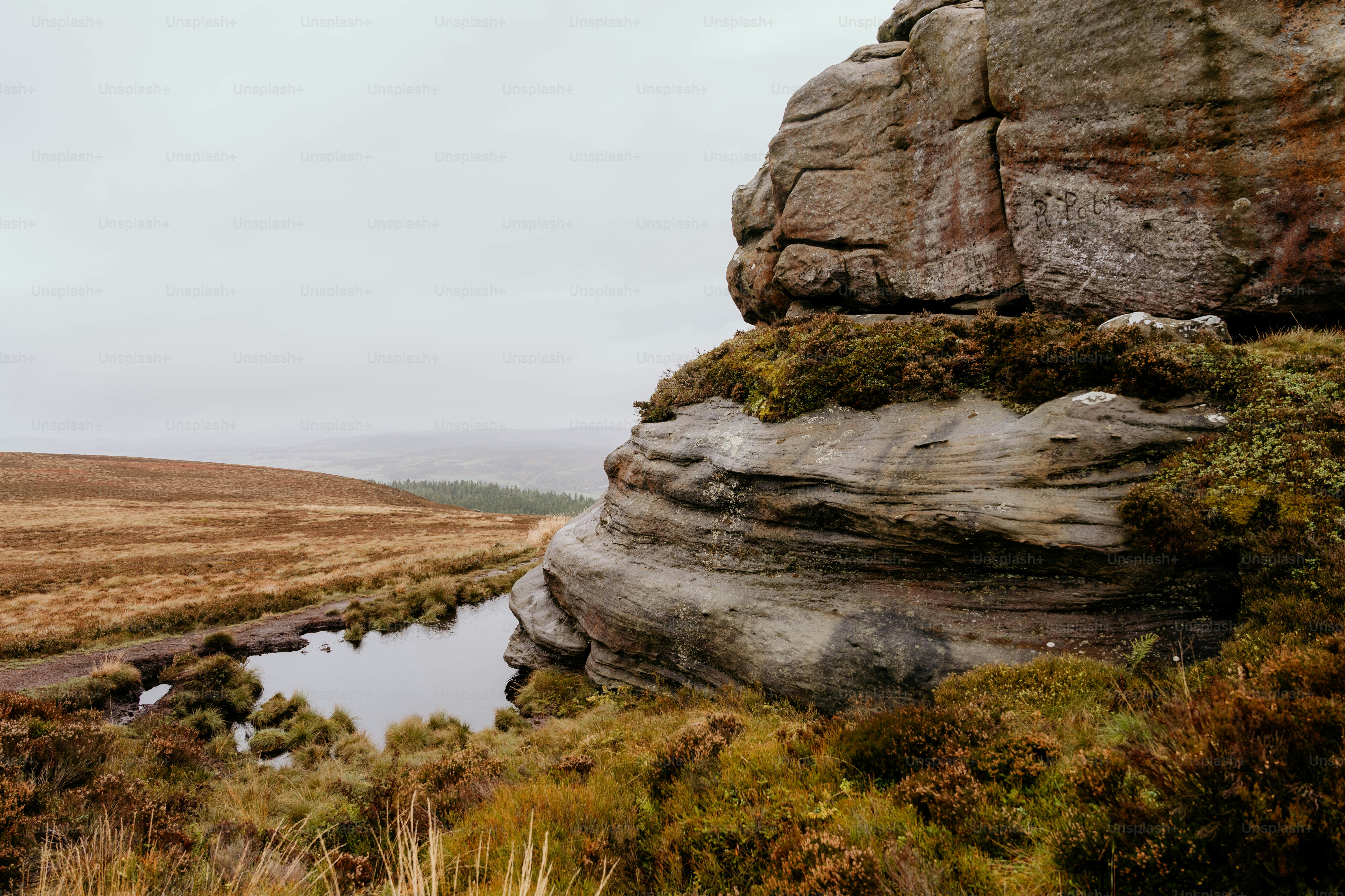 A rocky cliff with a small stream running between it photo ...