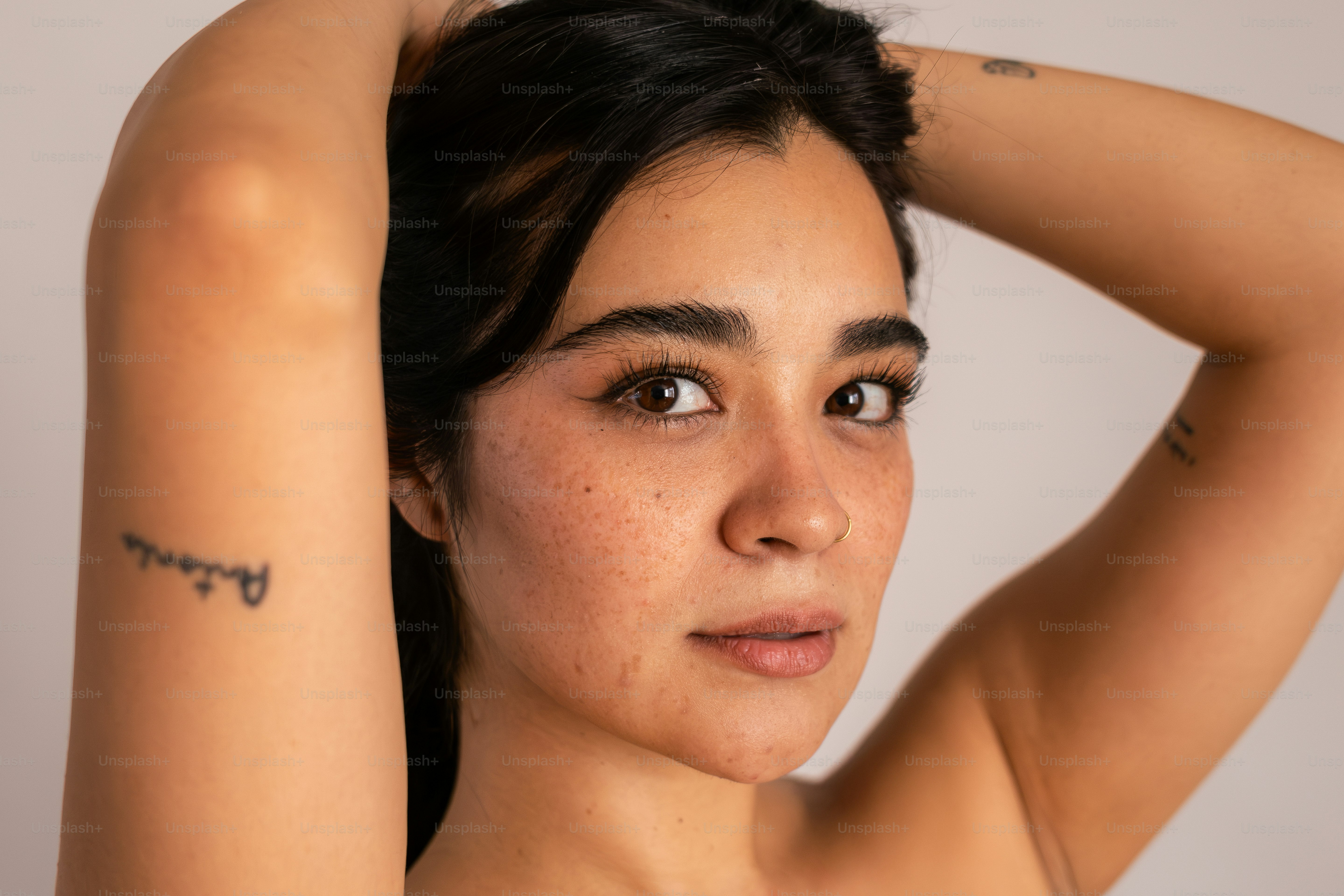 A woman with a tattoo on her arm photo – Minimalist portraits Image on ...