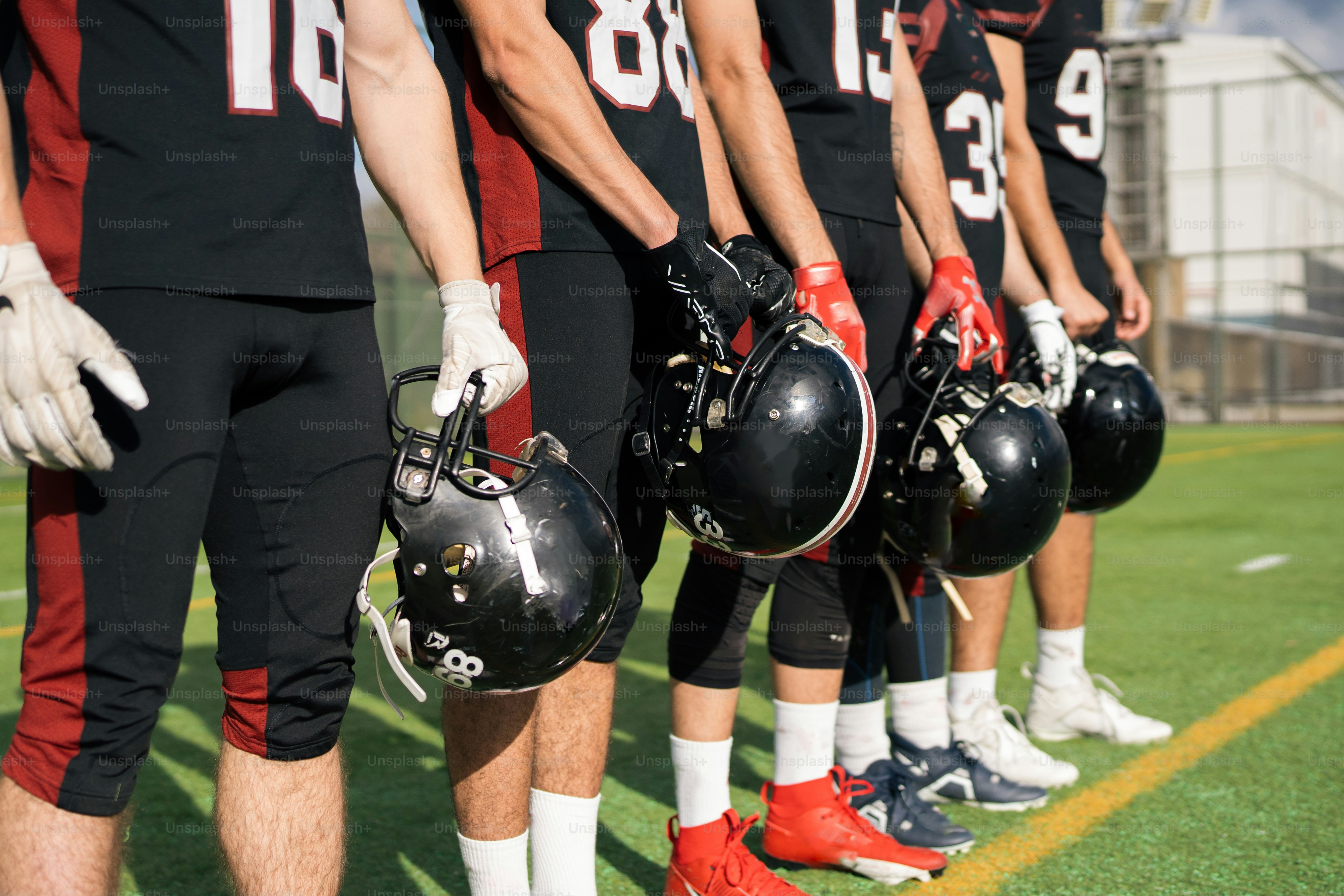 A group of football players standing on a field photo – Football Image ...