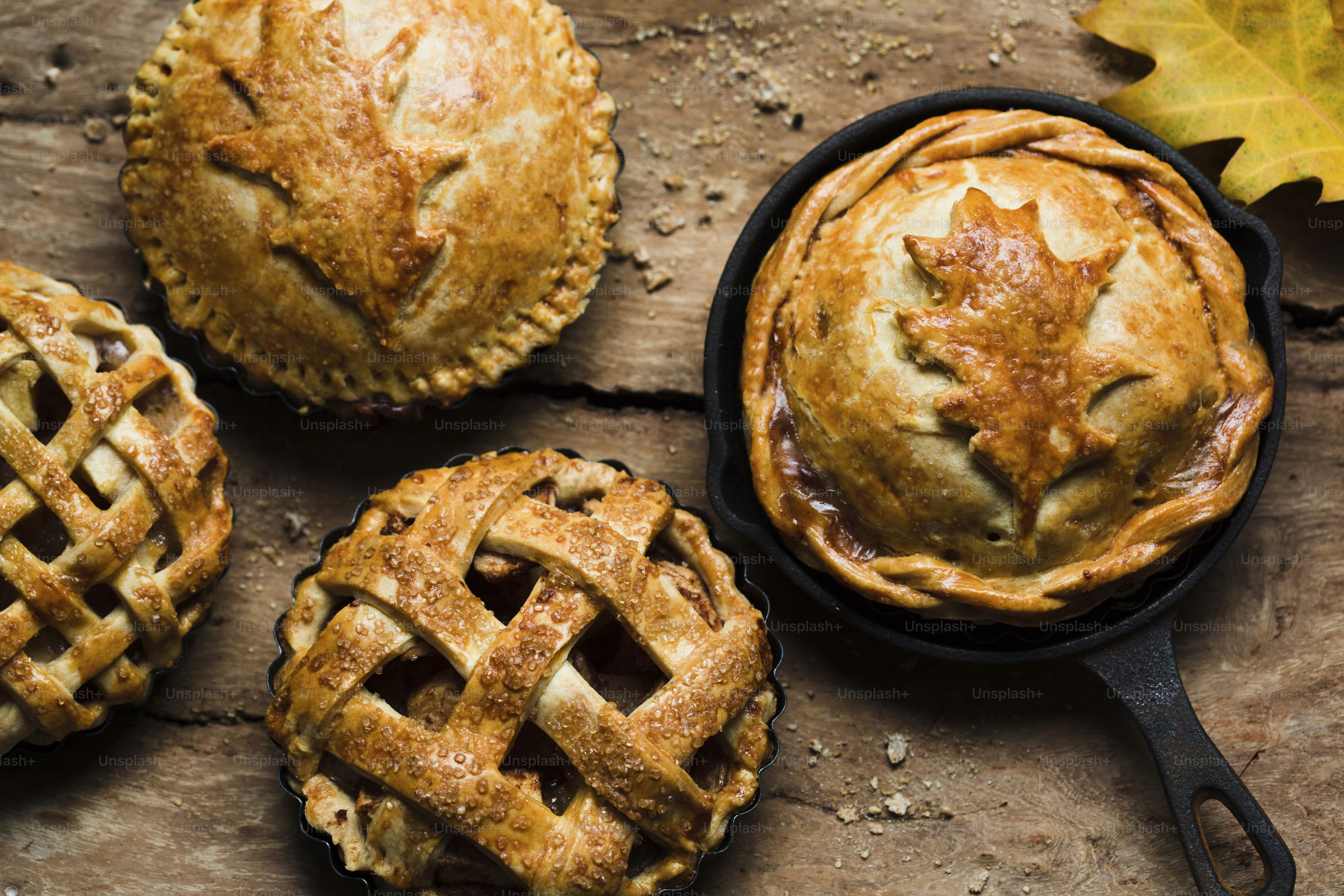 Four pies sitting on top of a wooden table photo – Food Image on Unsplash