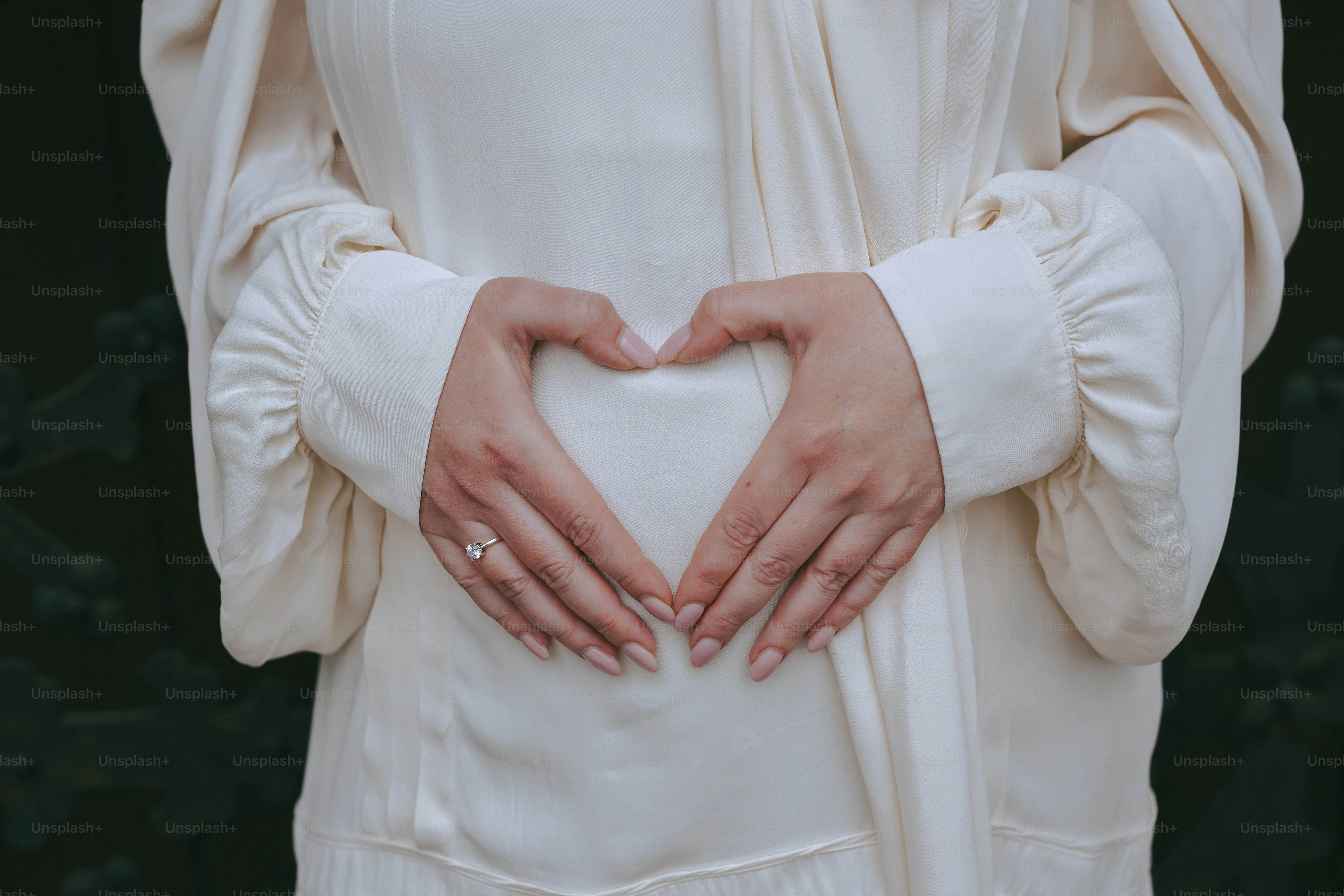 A woman with her hands in the shape of a heart photo – Wedding Image on ...