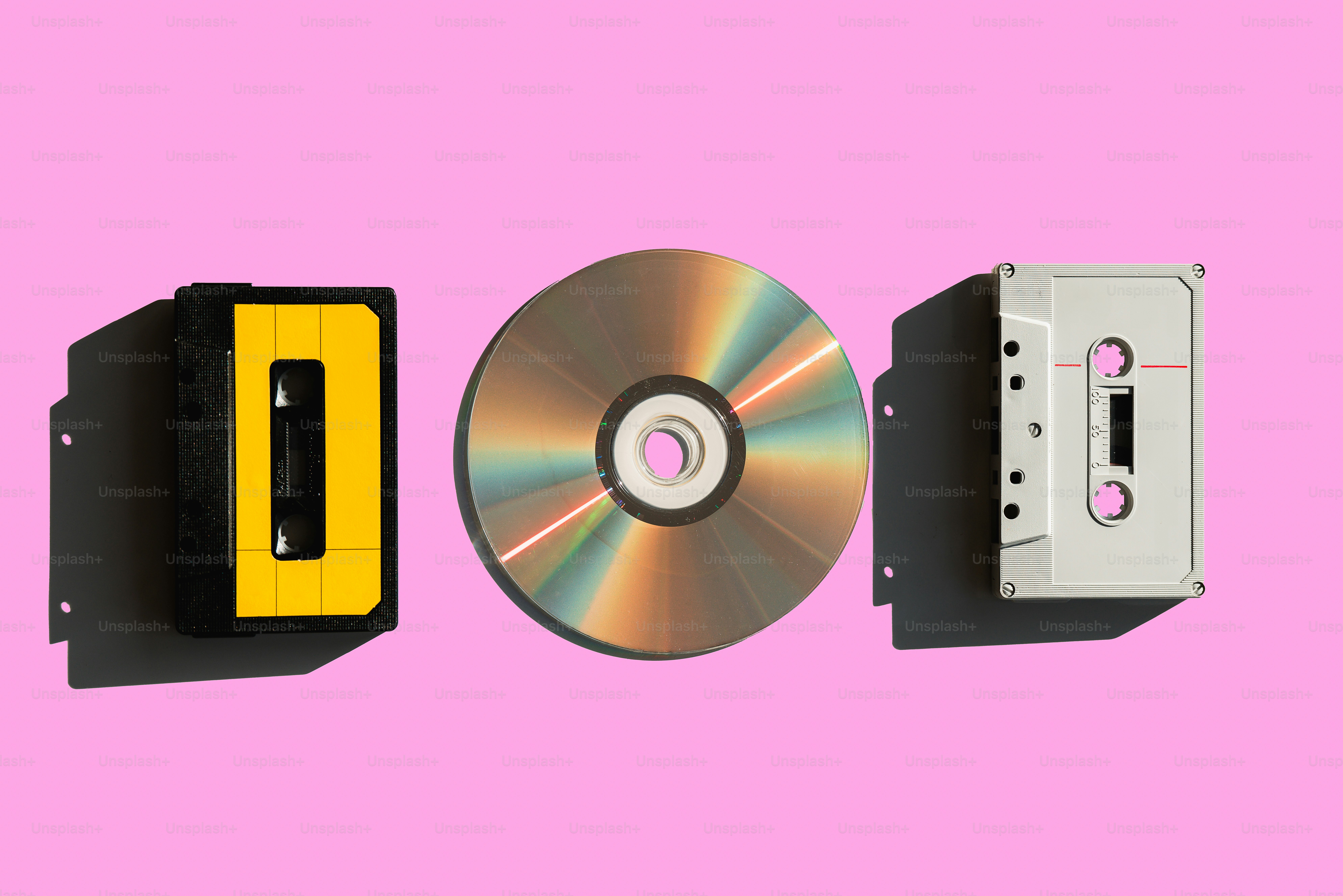 A group of different types of cd's on a pink background photo – Old ...