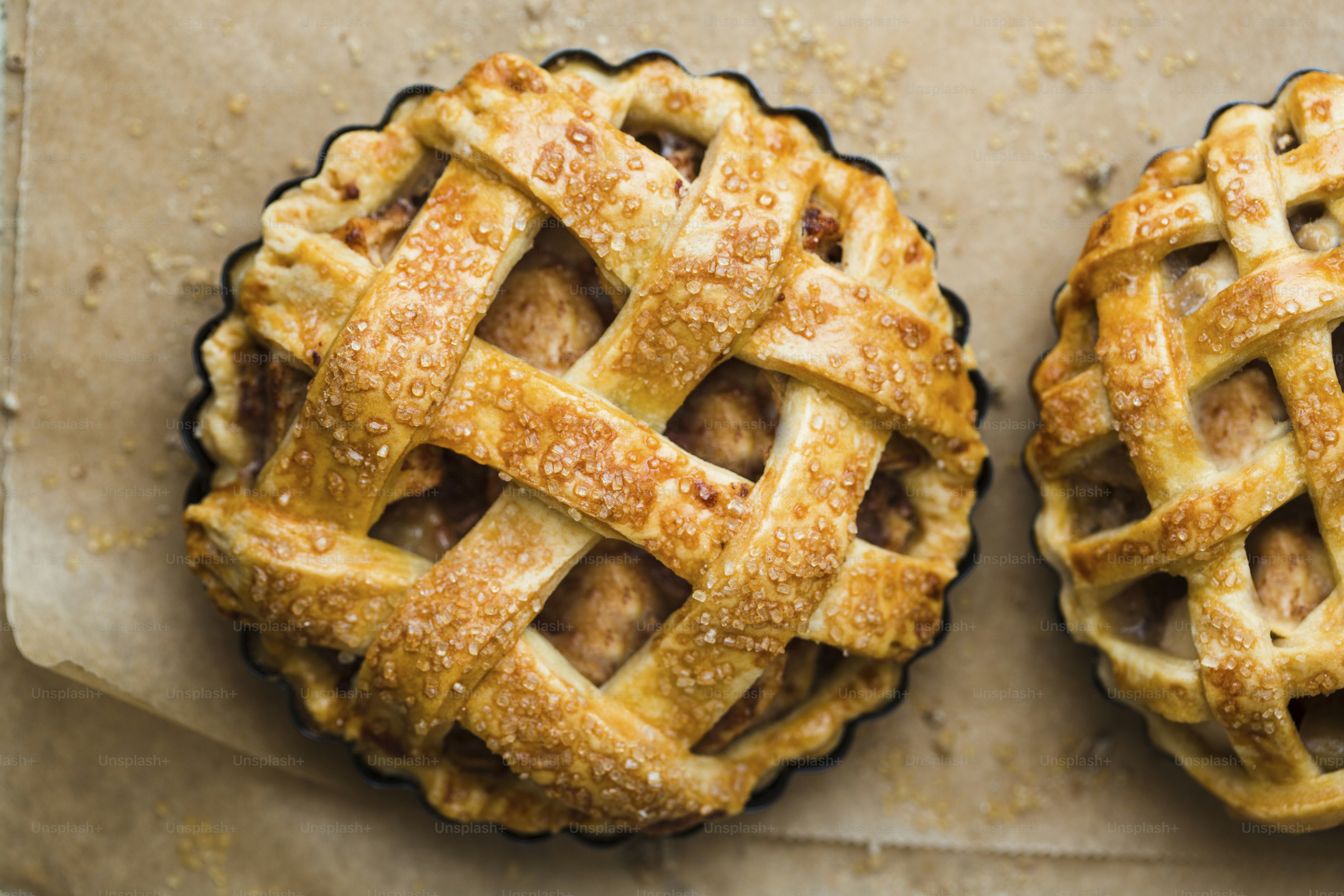 Two pies sitting on top of a piece of parchment paper photo – Food ...