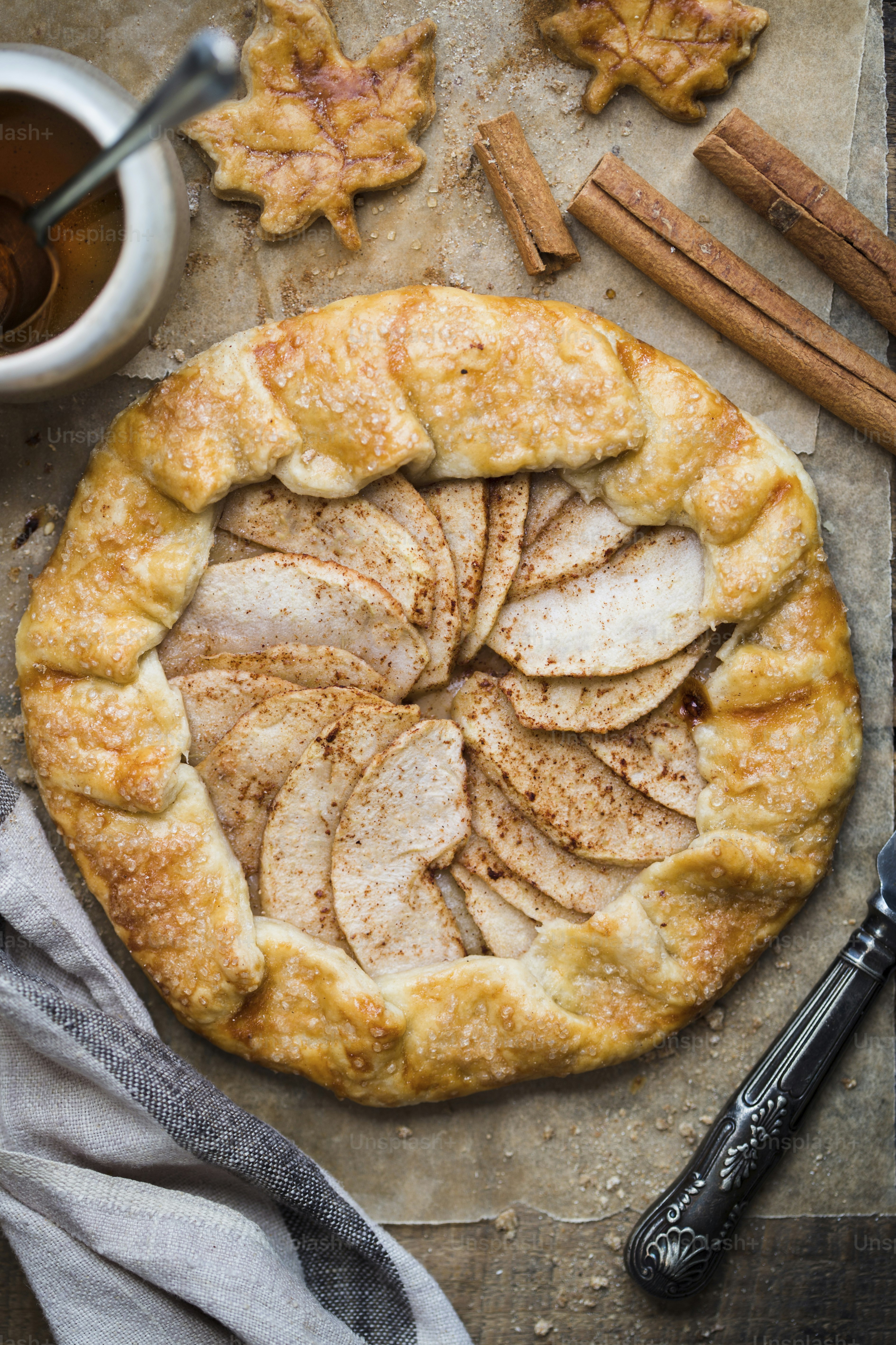 An apple pie with cinnamon sticks and a cup of tea photo – Food Image ...