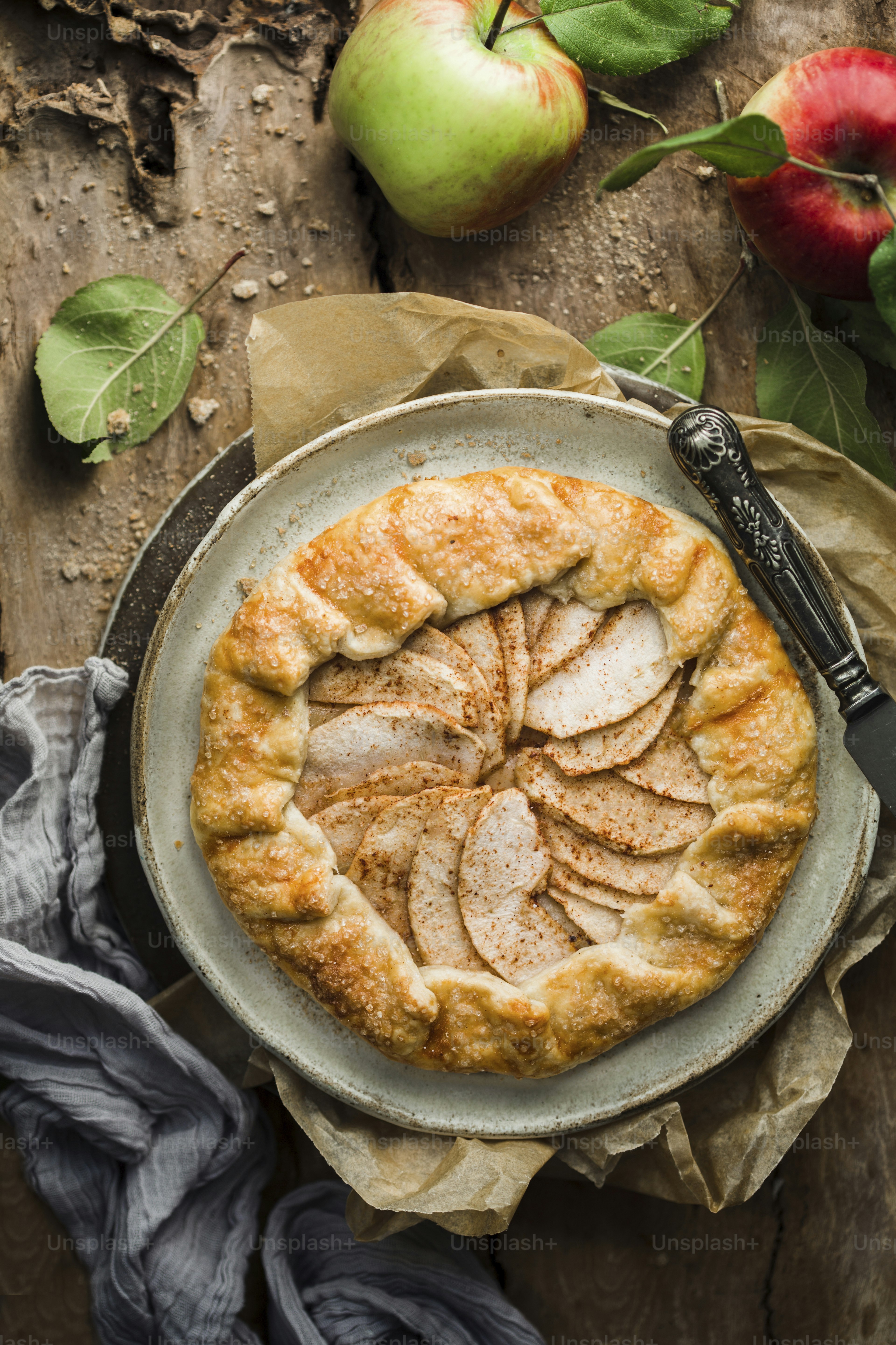 A pie with slices cut out of it on a plate photo – Autumn recipes Image ...