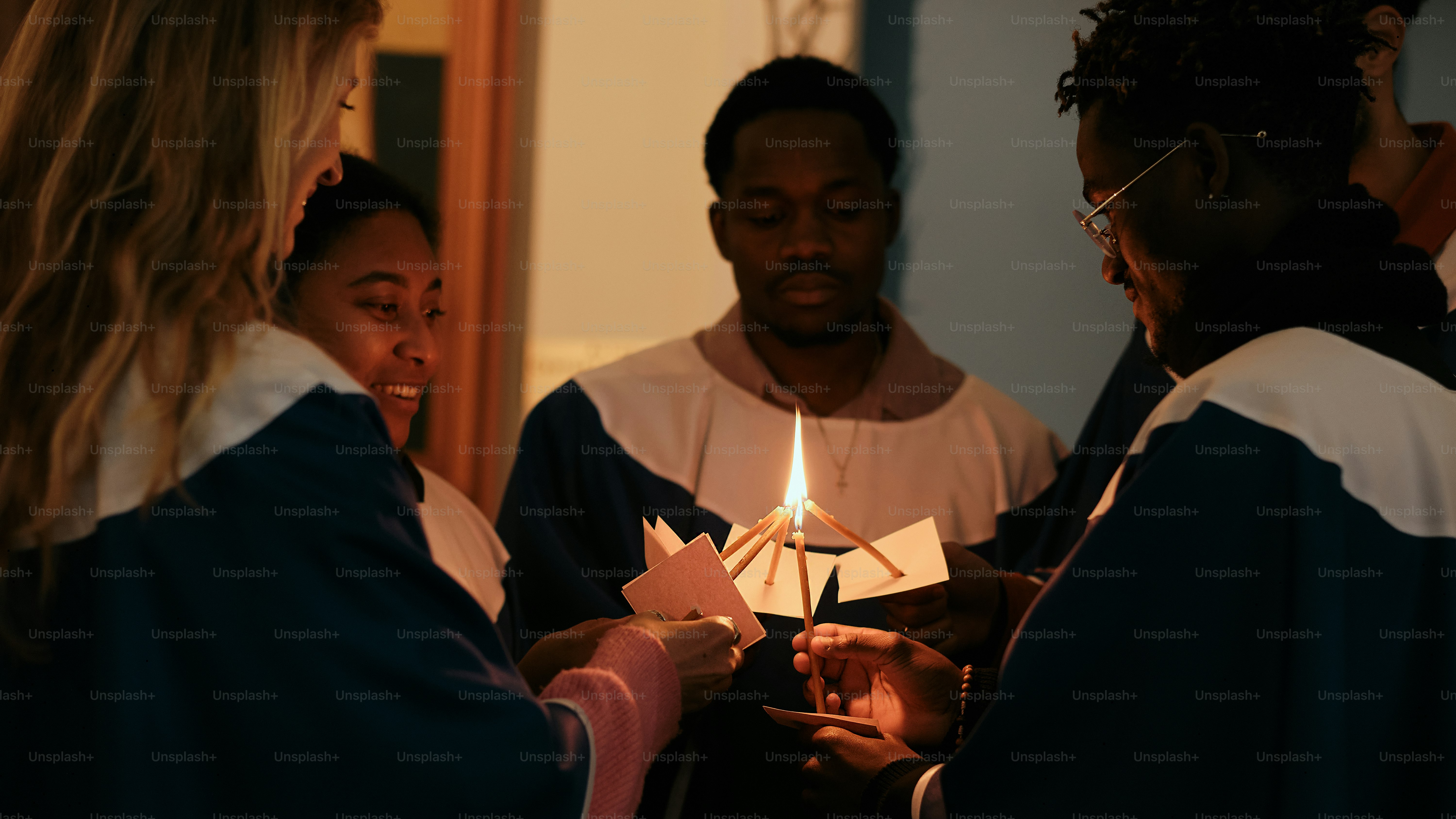 A group of people standing around a candle photo – Church choir Image ...