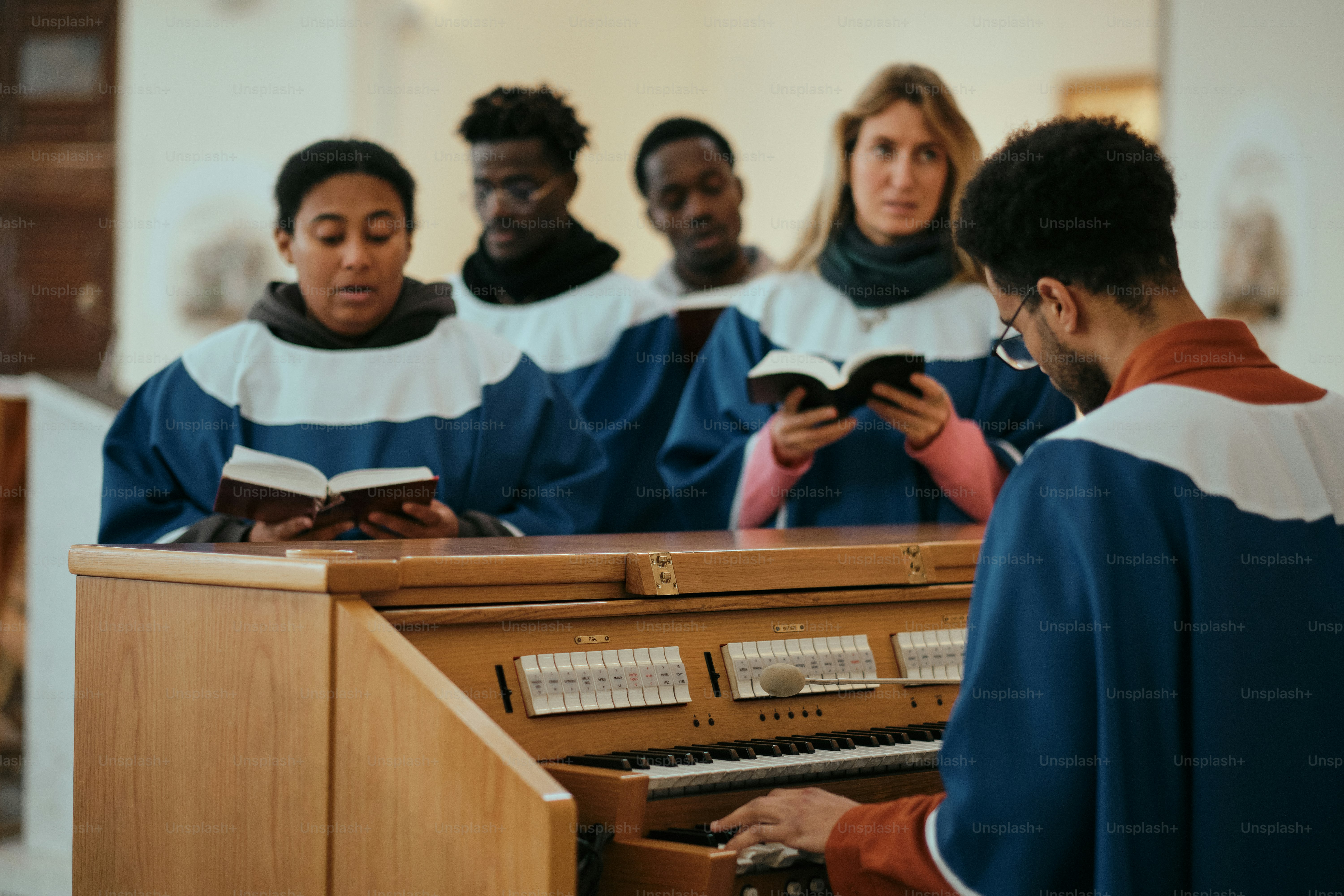 A group of people standing around a piano photo – Multiethnic Image on ...