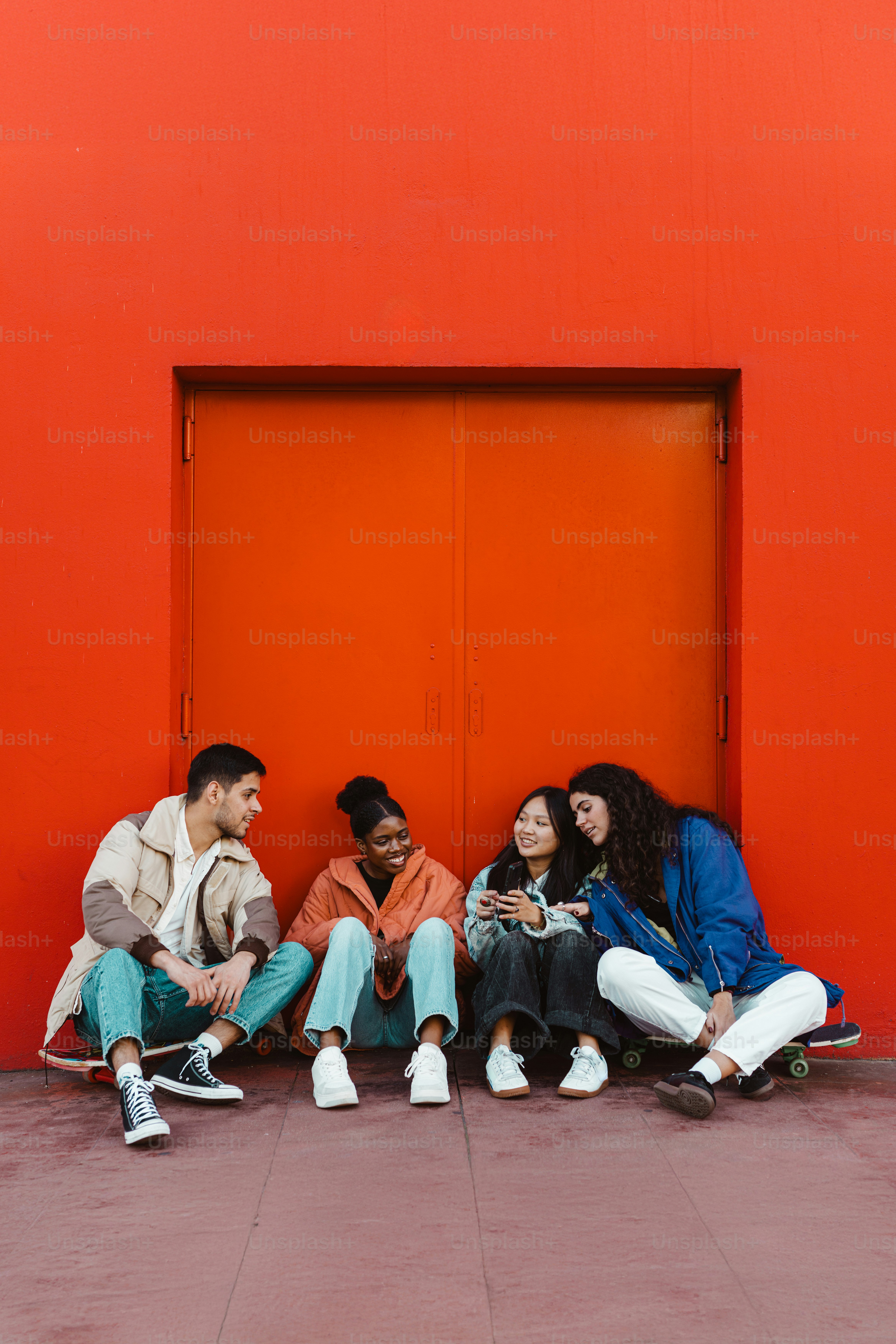A group of people sitting next to each other photo – Friendships Image ...