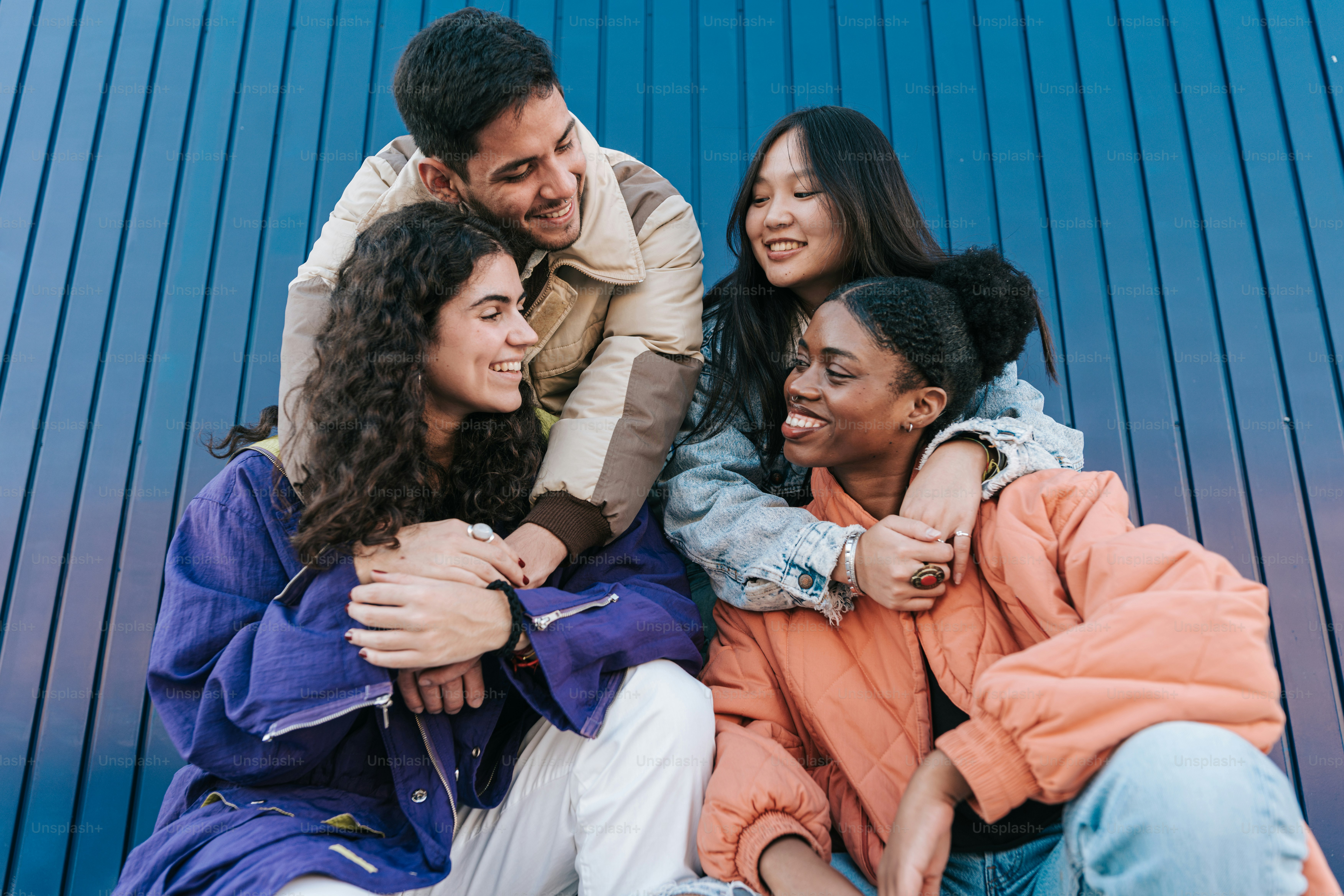 A group of people sitting on top of each other photo – Friendships ...