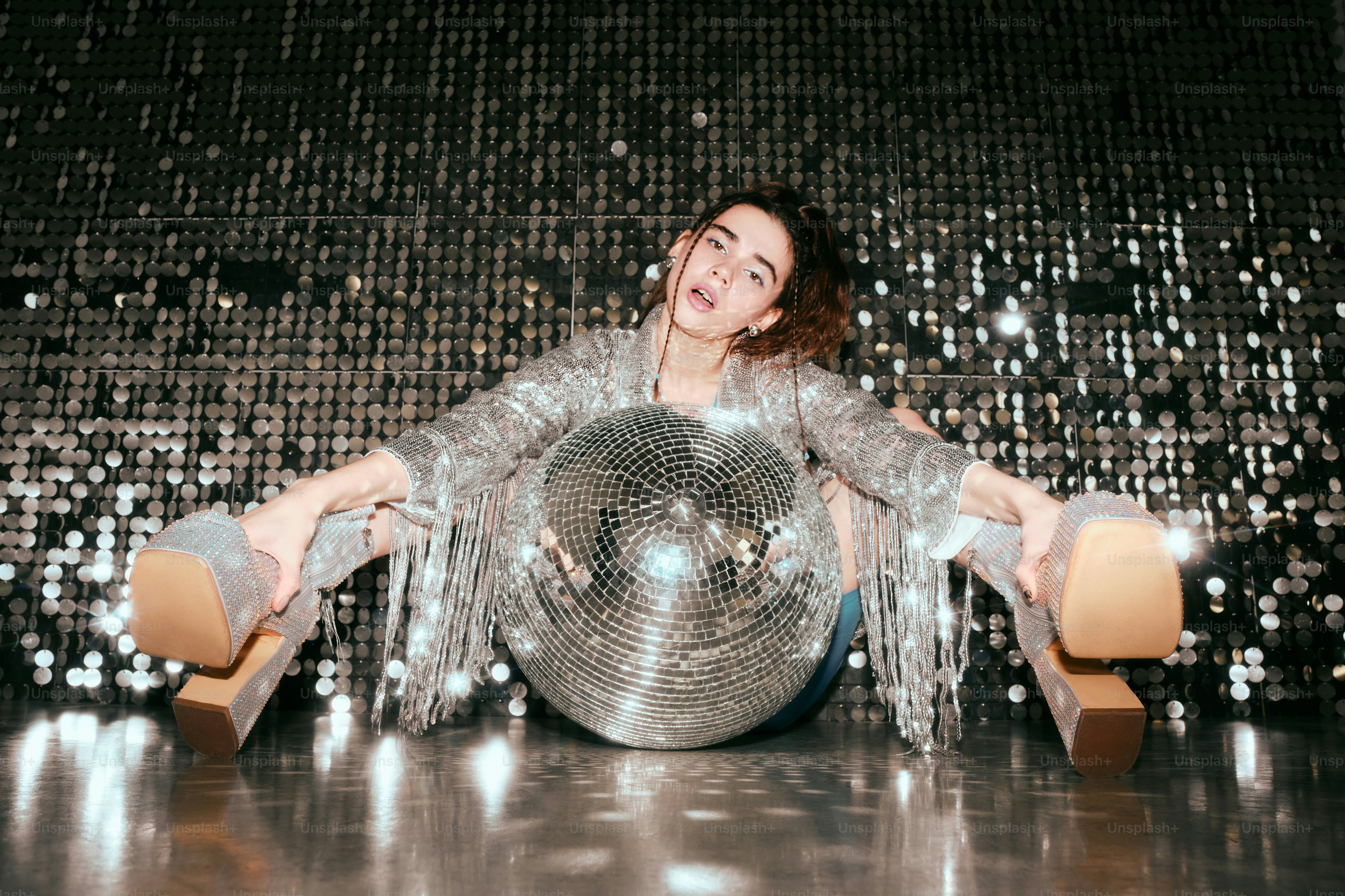 A woman sitting on the ground with a disco ball photo – 90s Image on ...