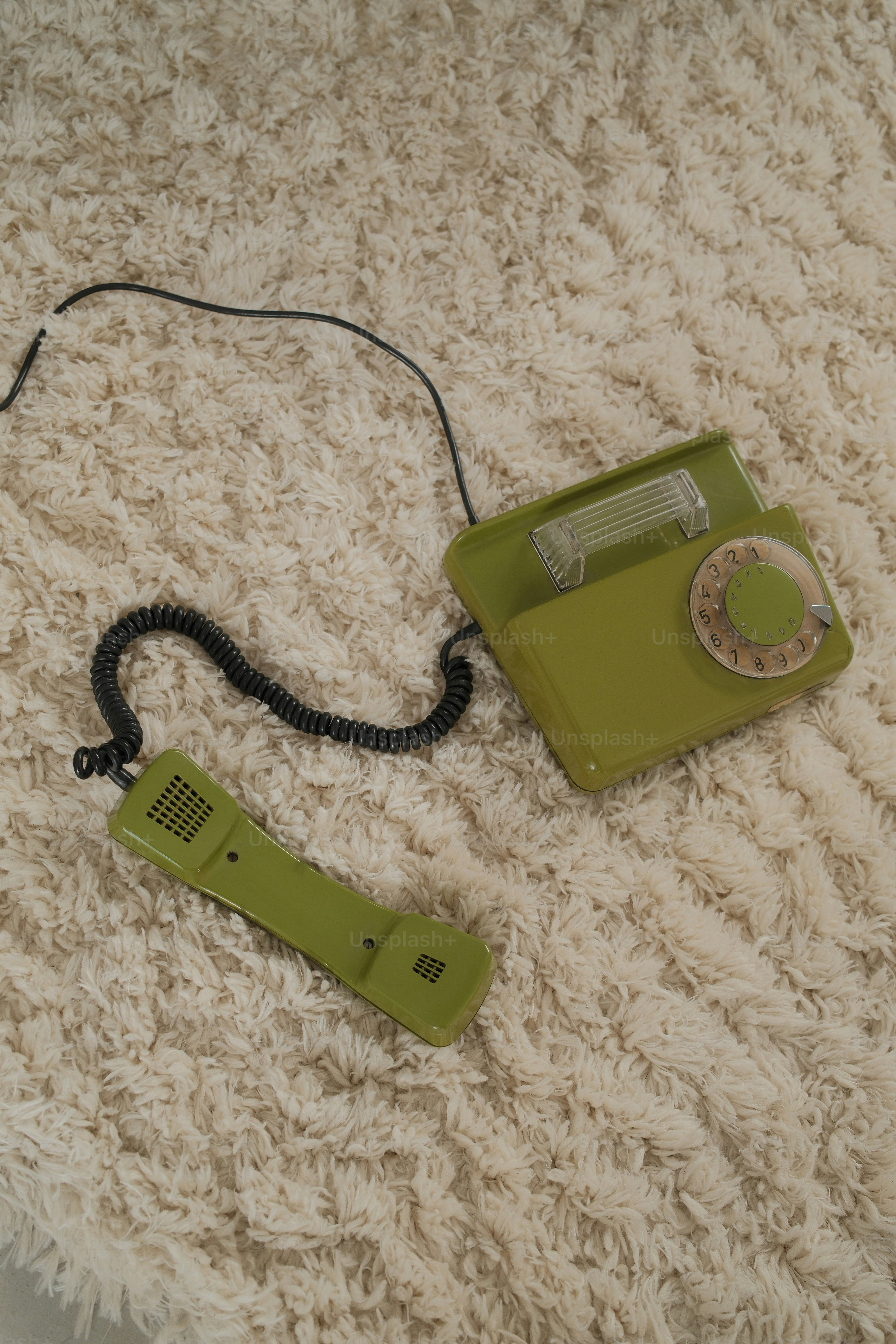 A green camera laying on a white carpet photo – Retro phone Image on ...