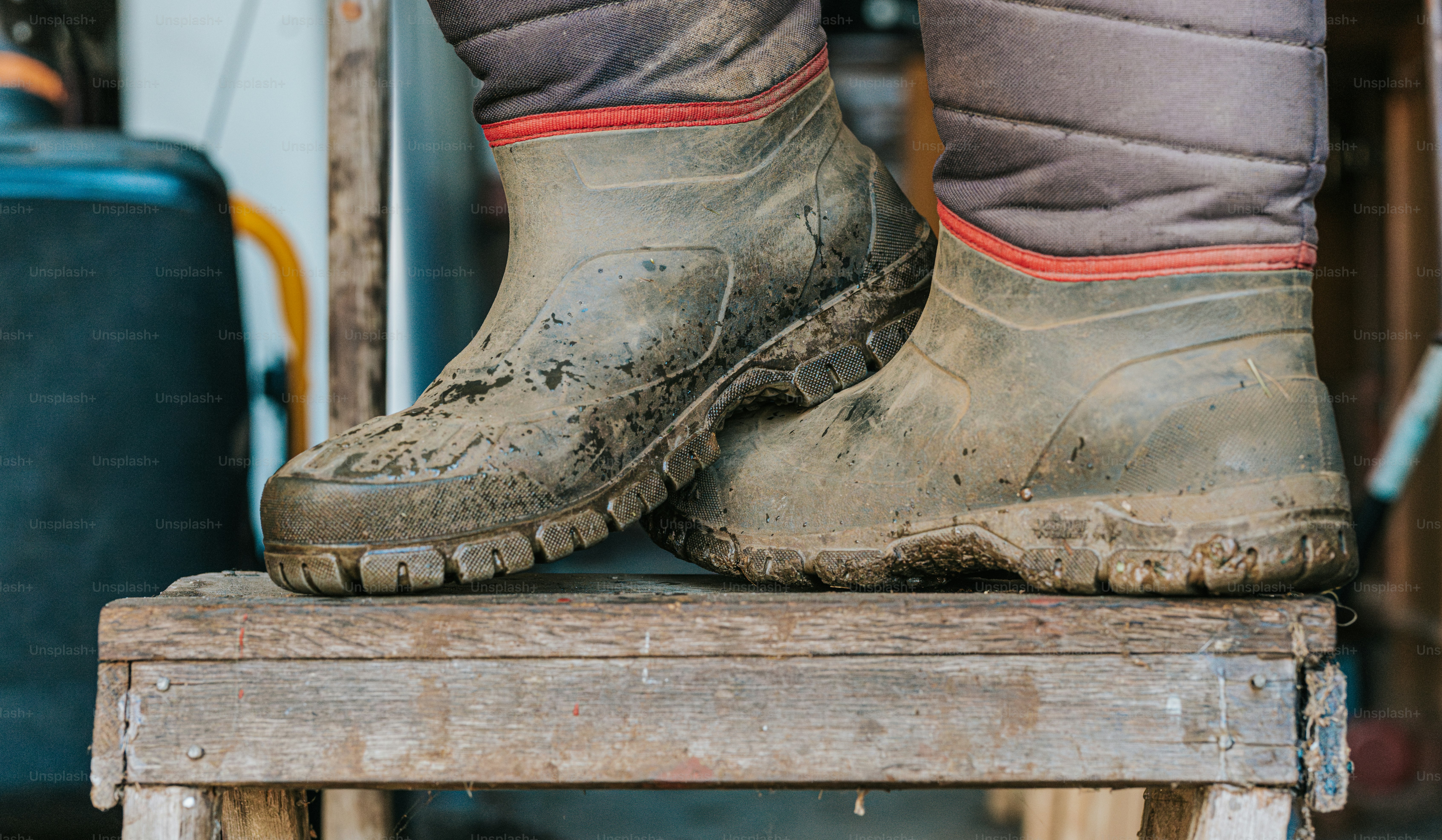 A pair of boots sitting on top of a wooden stool photo – Fashion Image ...