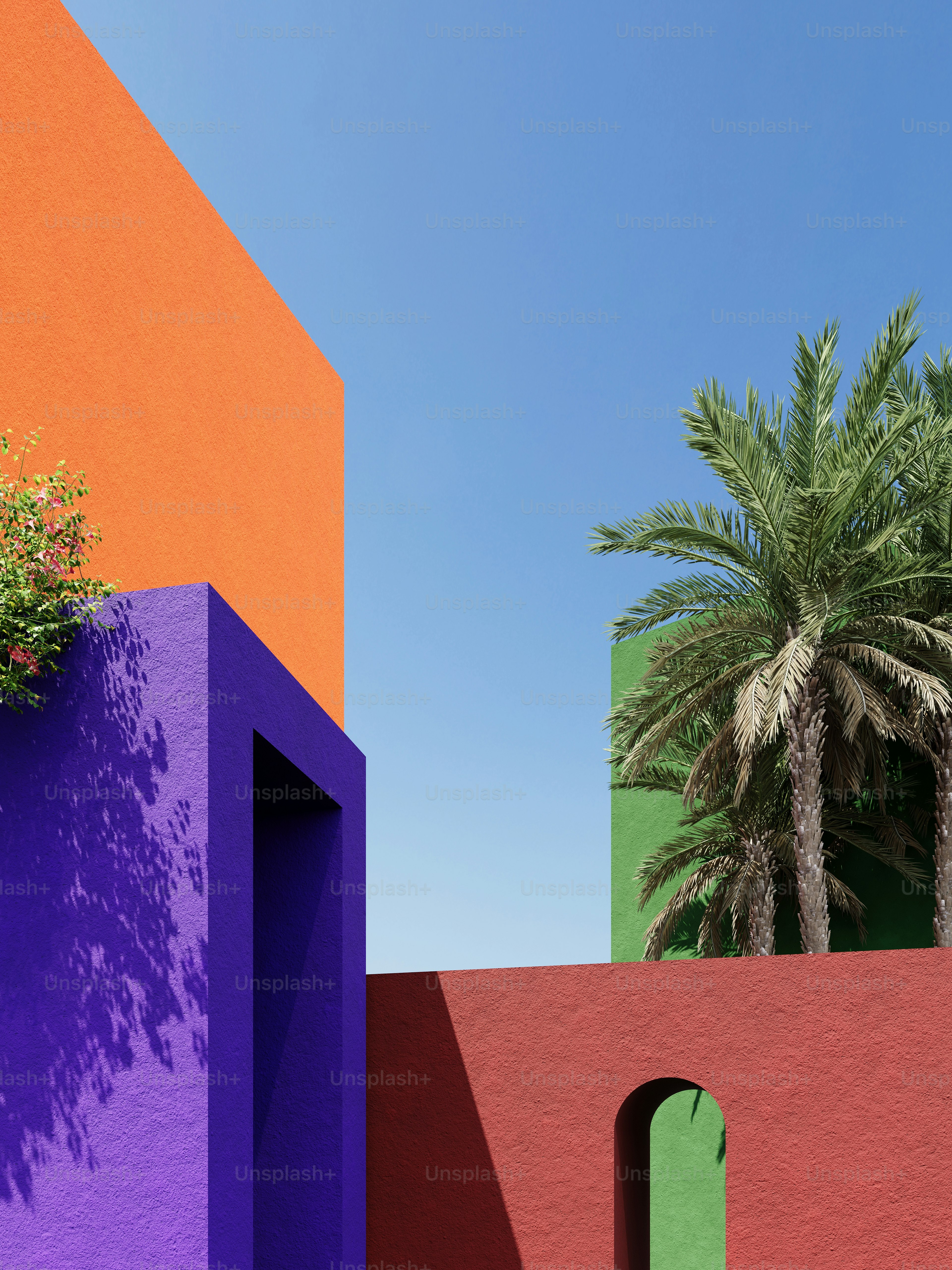 A colorful building with palm trees in the background photo – Colorful ...