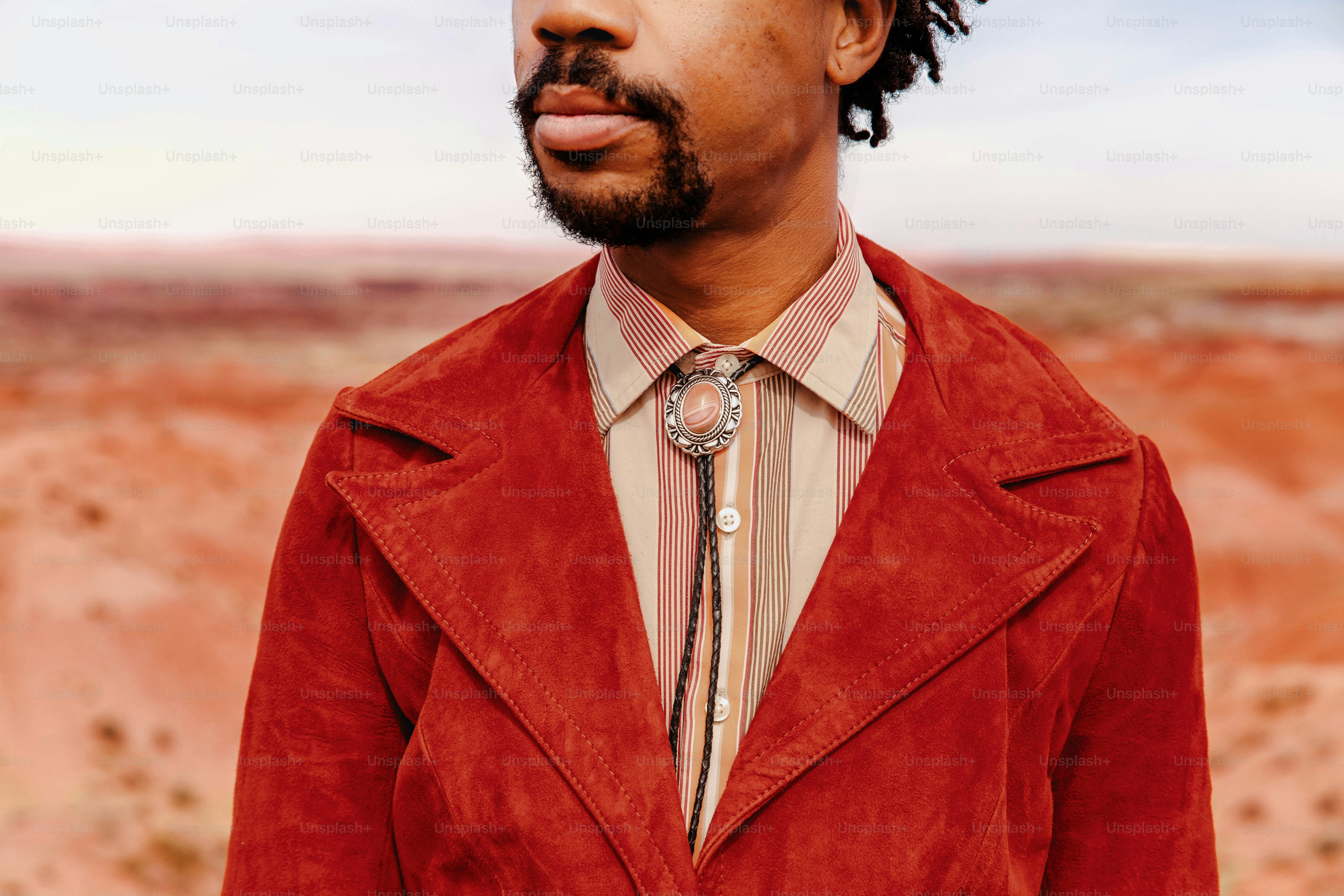 A man with dreadlocks wearing a red jacket and tie photo – Desert ...