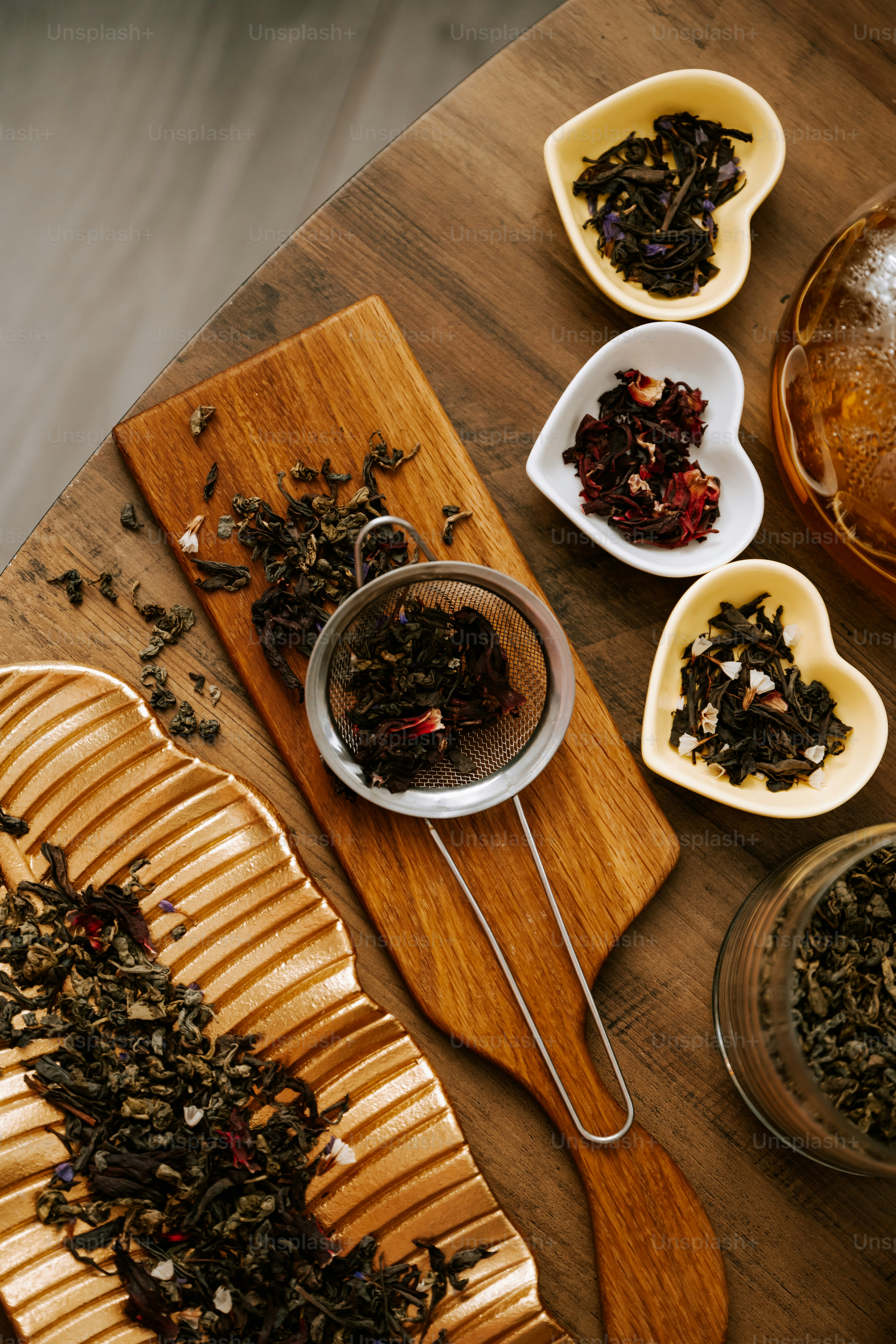 A wooden table topped with lots of different types of tea photo – Tea ...
