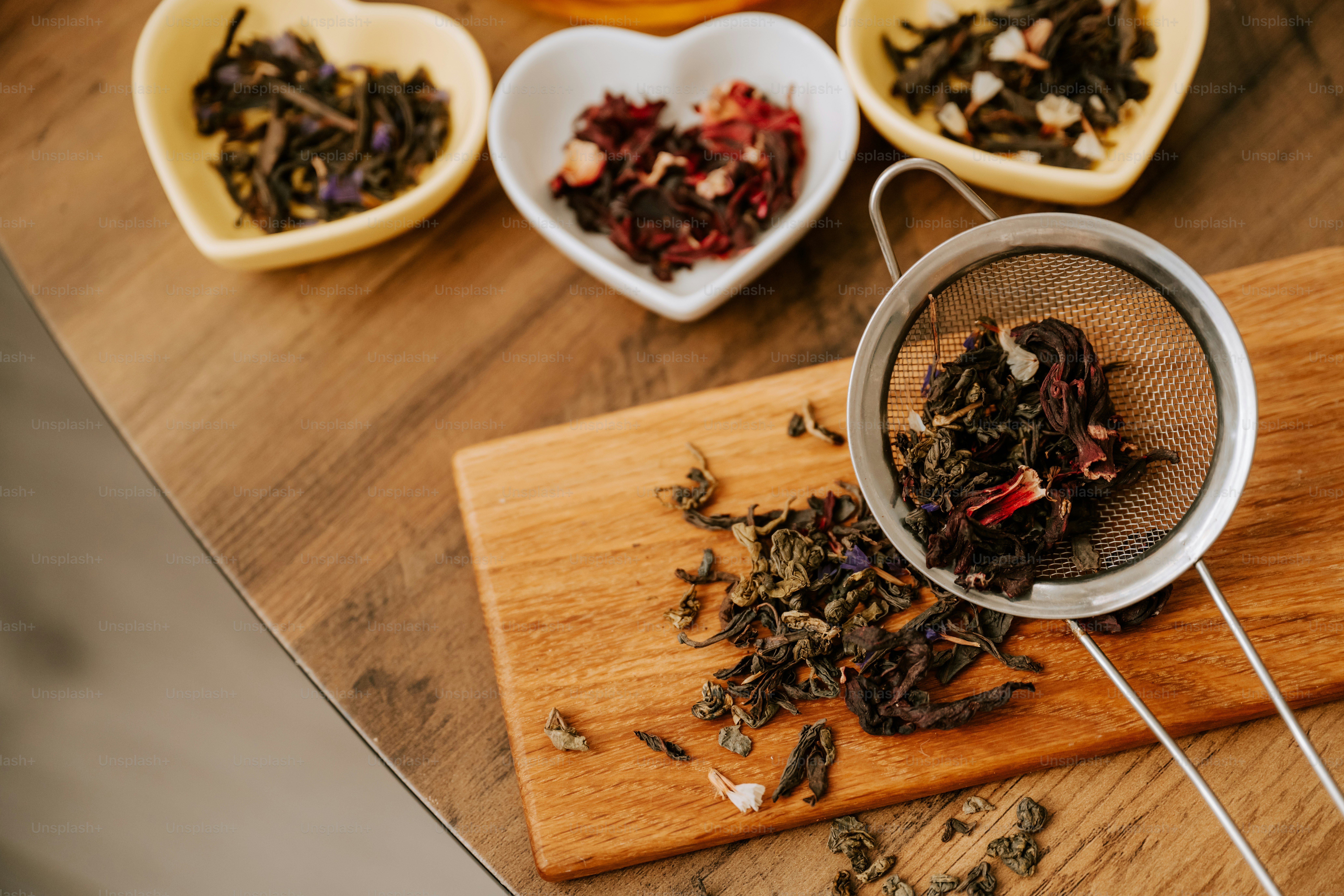 A wooden table topped with lots of different types of tea photo – Tea ...