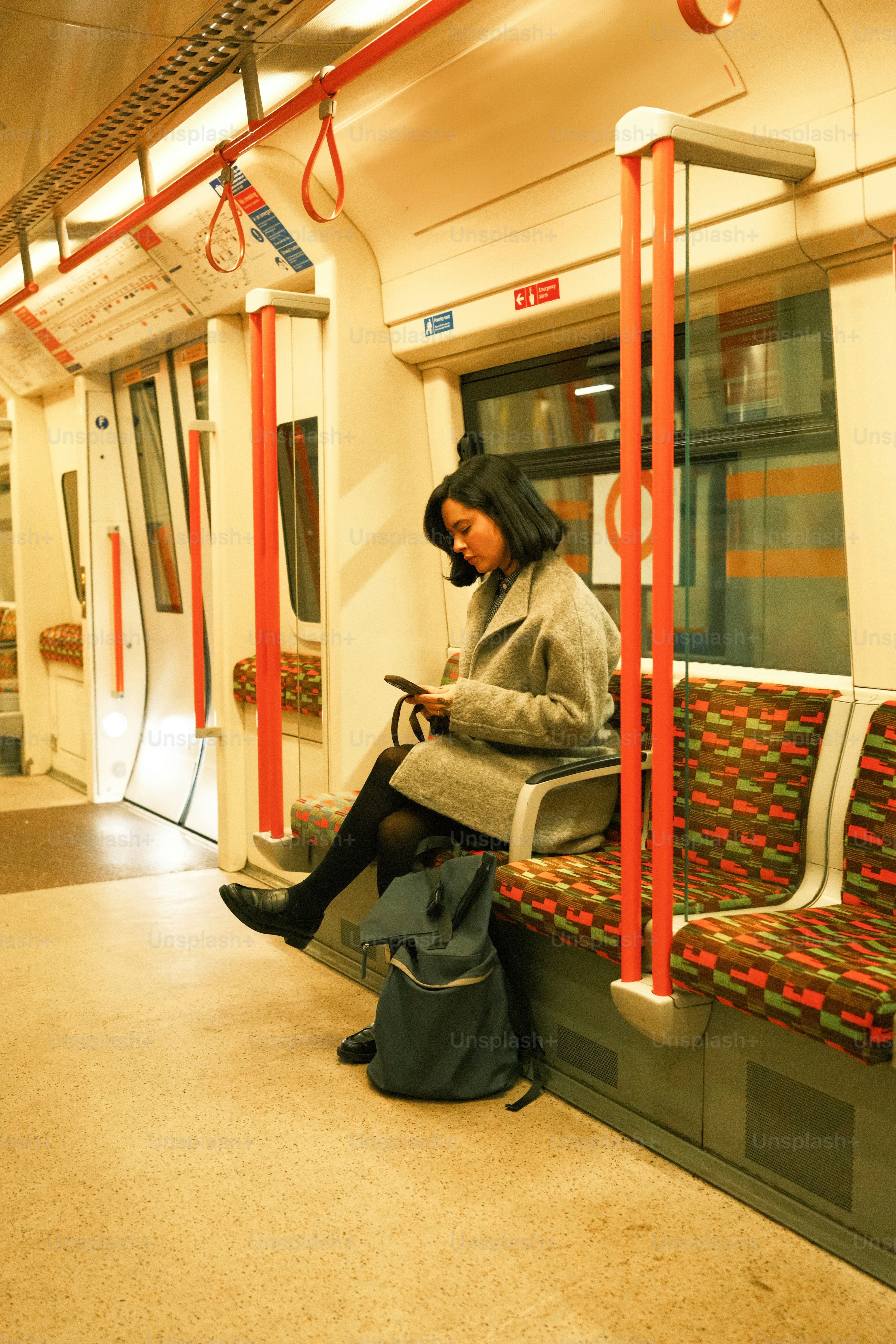 A woman sitting on a train looking up at the sky photo – Travel Image ...