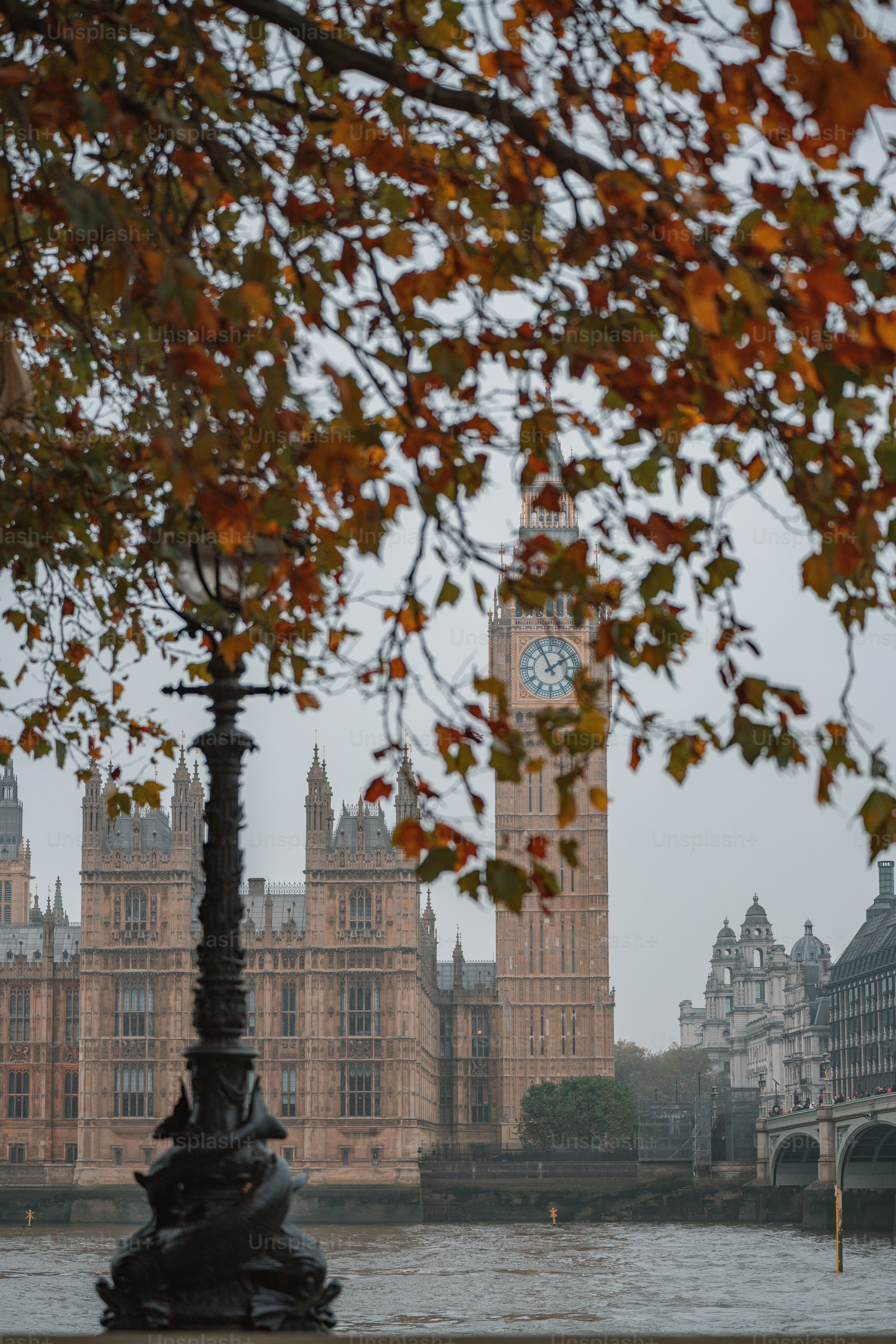 A clock tower towering over a body of water photo – City Image on Unsplash