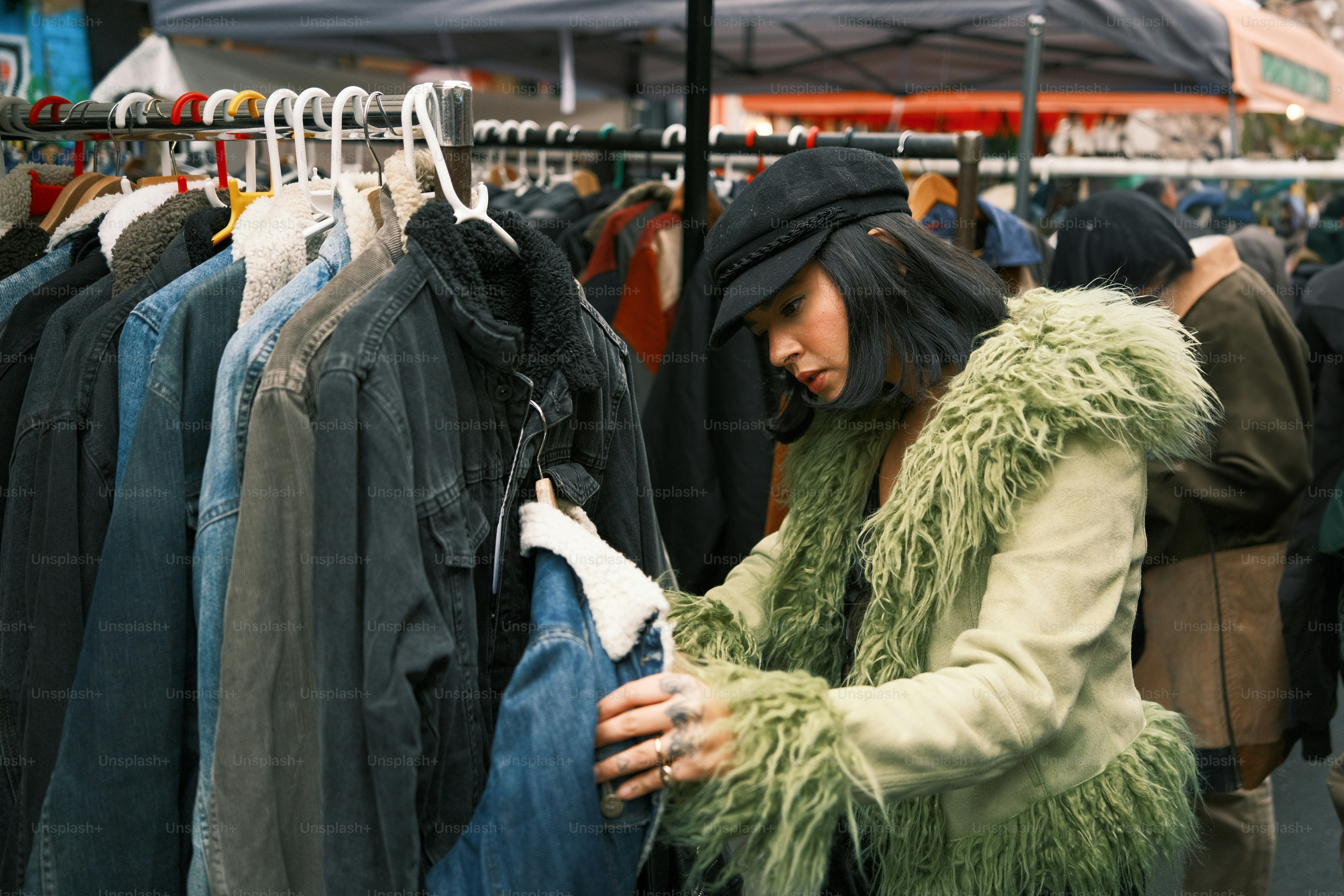 A woman looking at clothes on a rack photo – Thrifting Image on Unsplash
