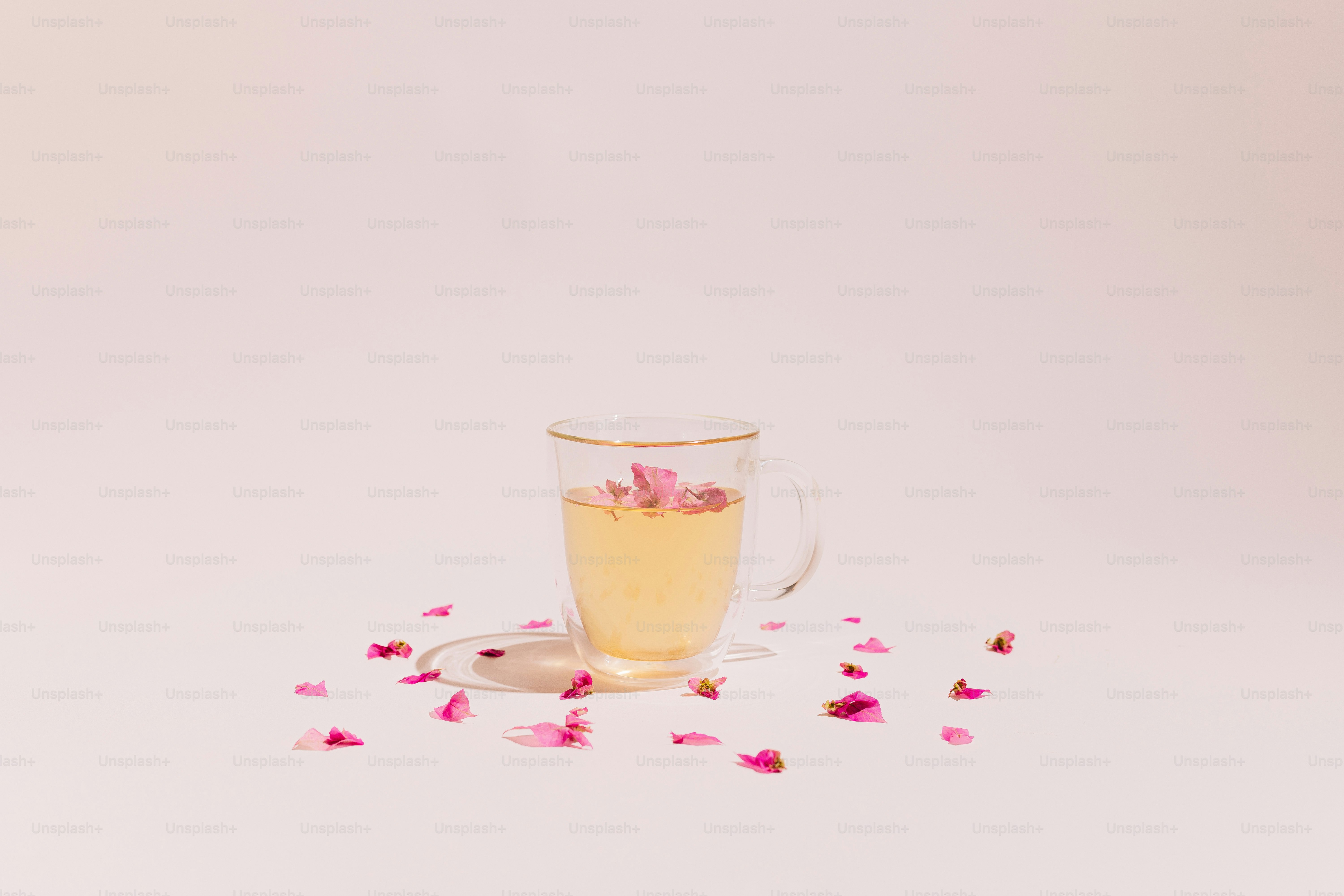 A cup of tea with rose petals on a table photo – Tea Image on Unsplash