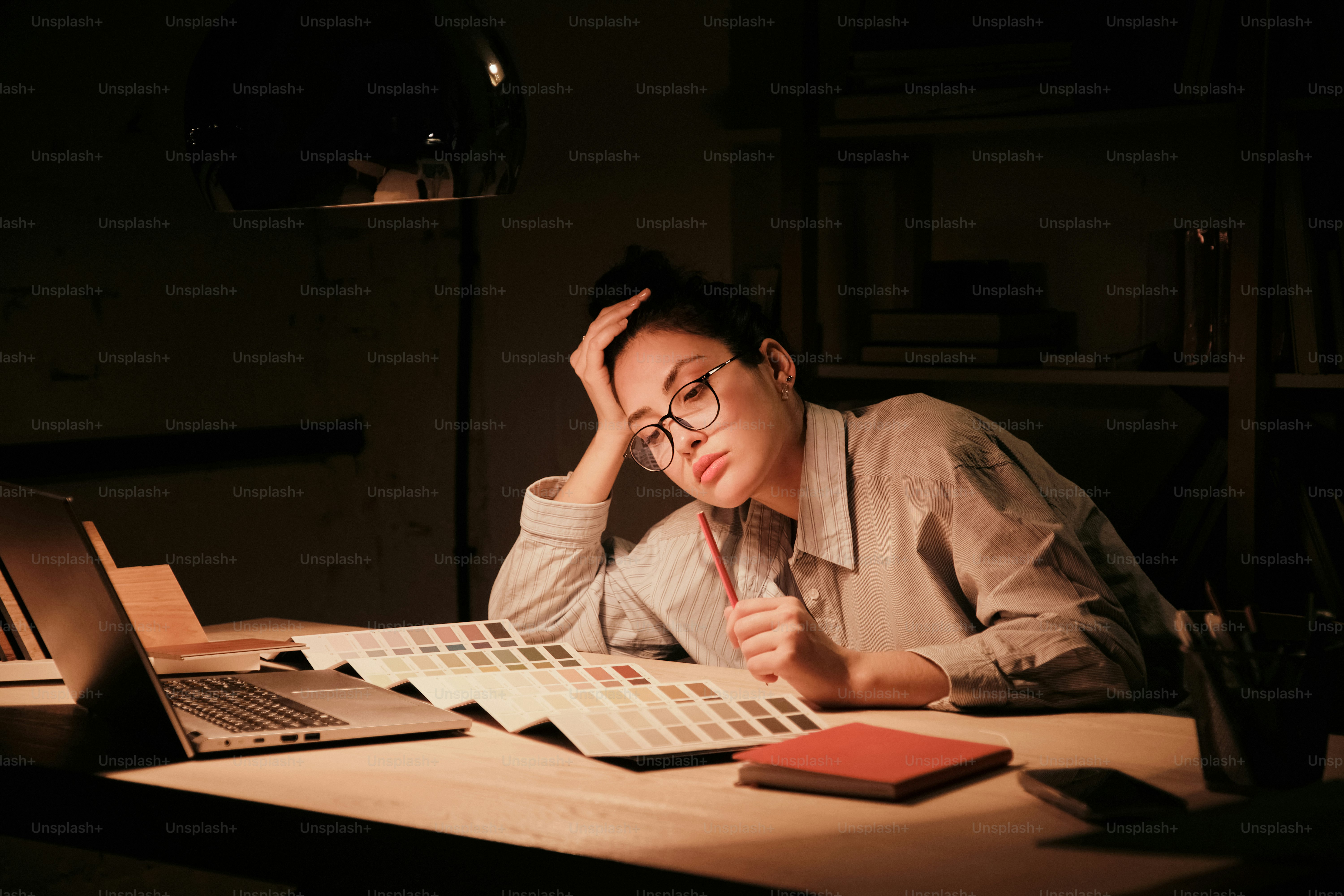 A woman sitting at a desk with a laptop computer photo – Office Image ...