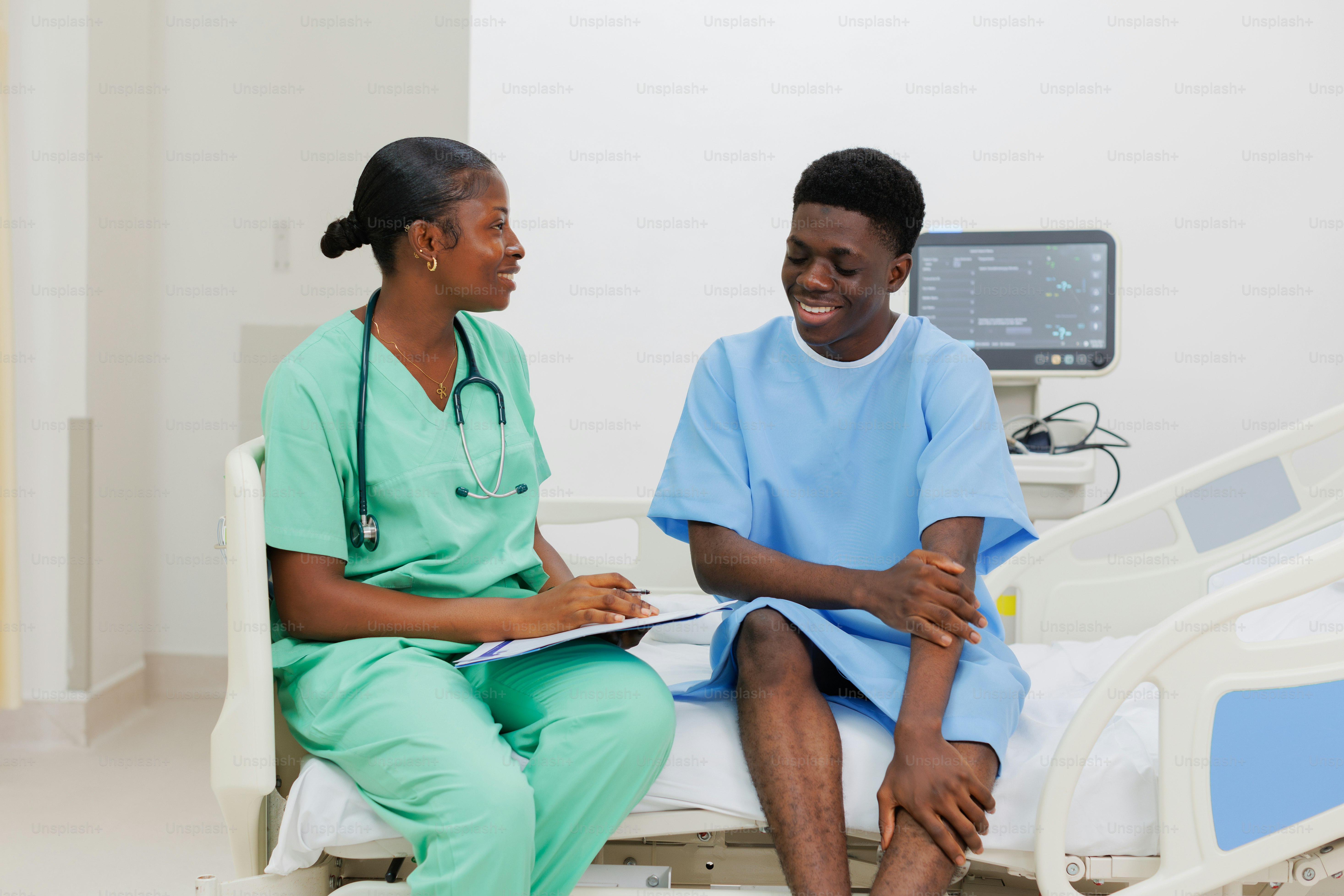 A woman in a hospital bed talking to a man in a hospital bed photo ...