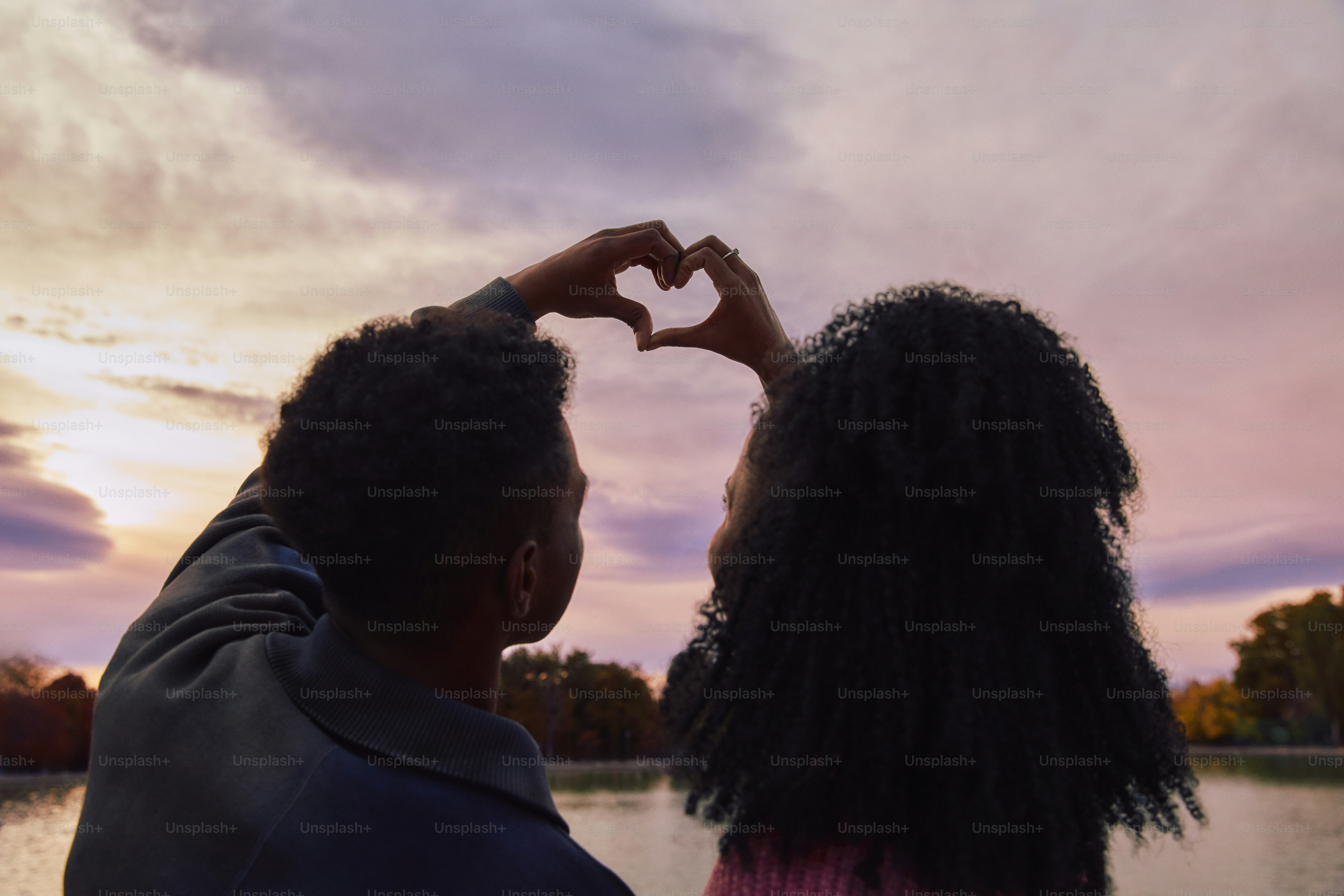A man and a woman holding a heart shape with their hands photo – Love ...