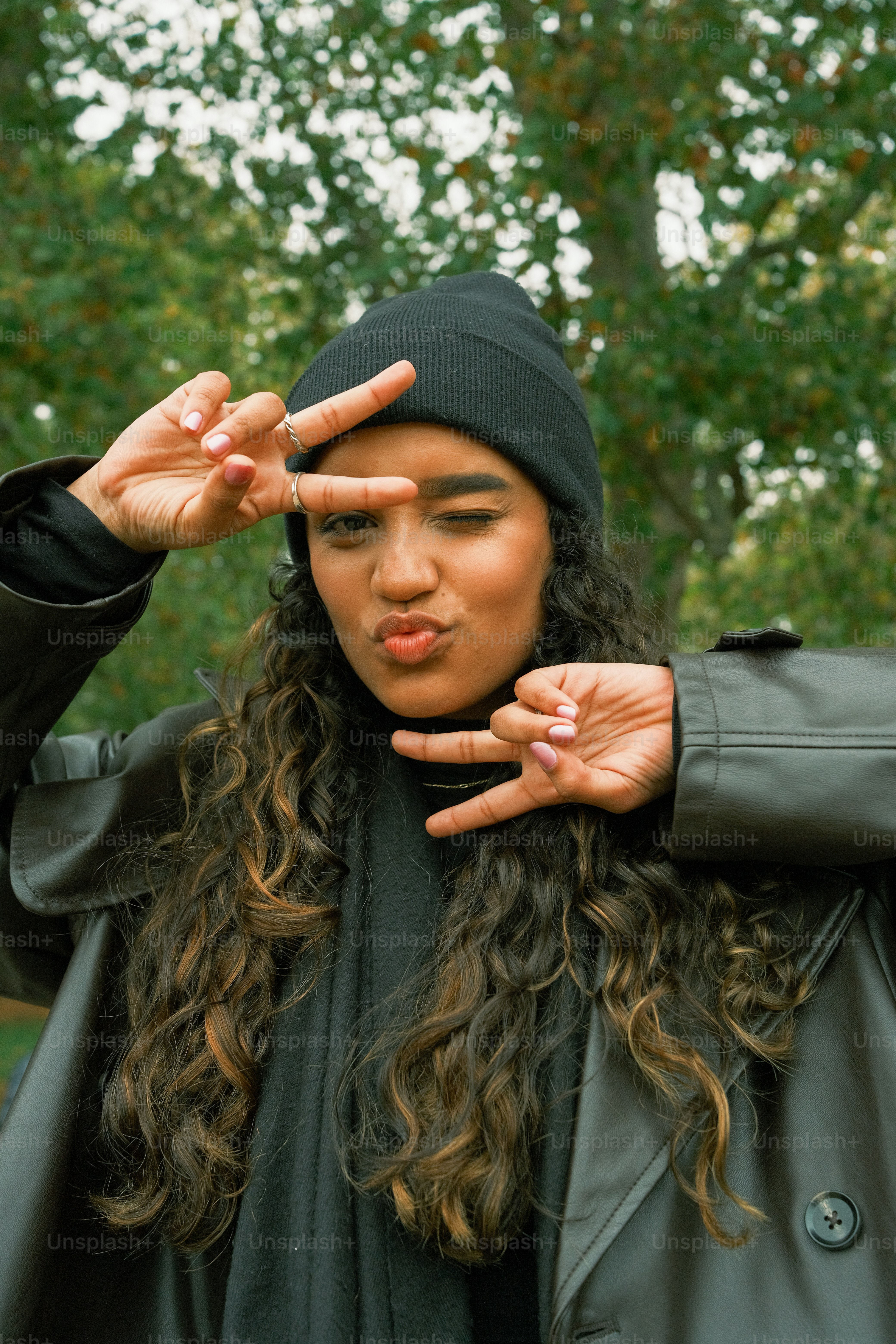A woman making a hand sign with her fingers photo – Profile Image on ...