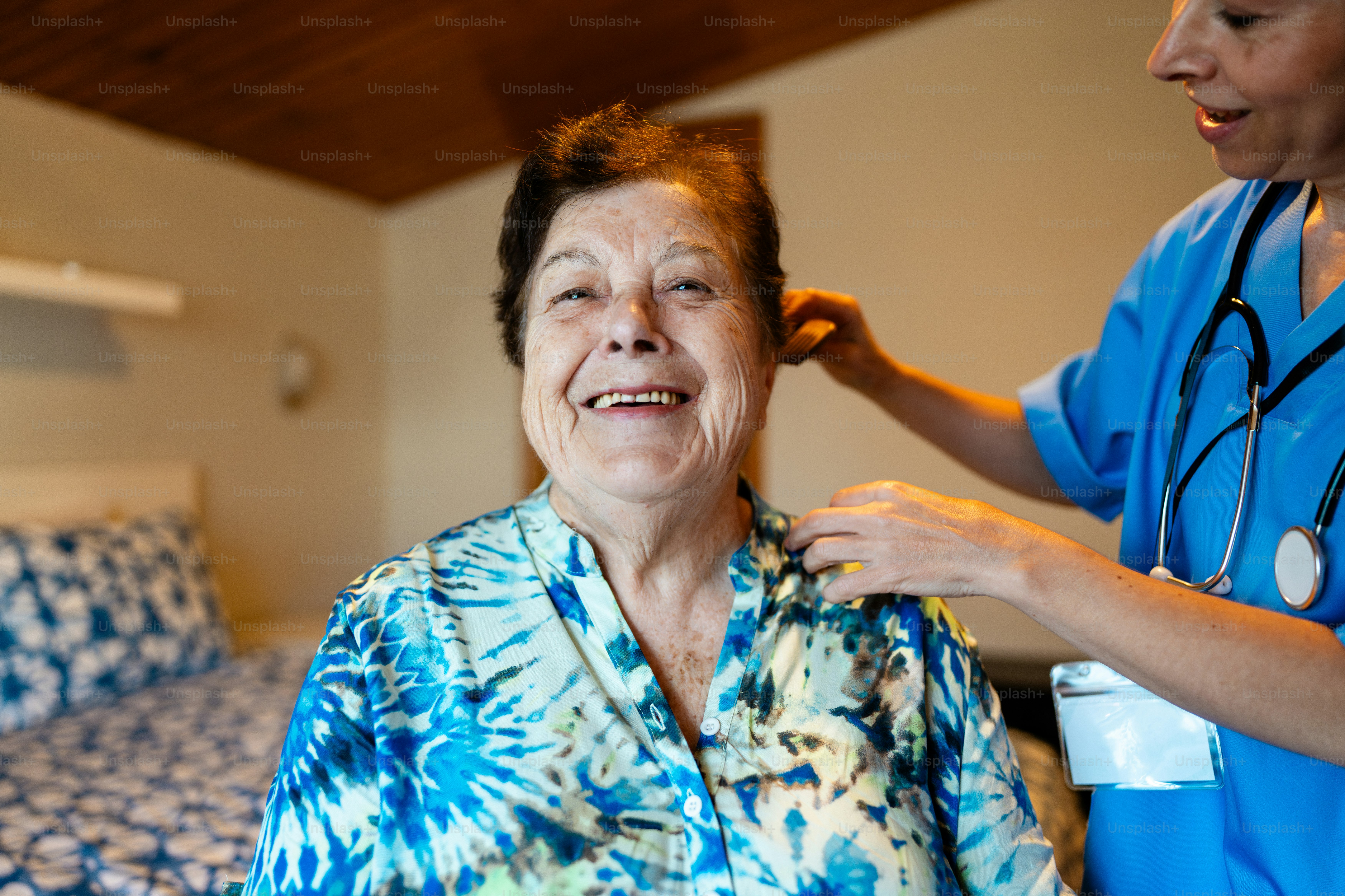 A woman getting her hair brushed by a nurse photo – Health Image on ...