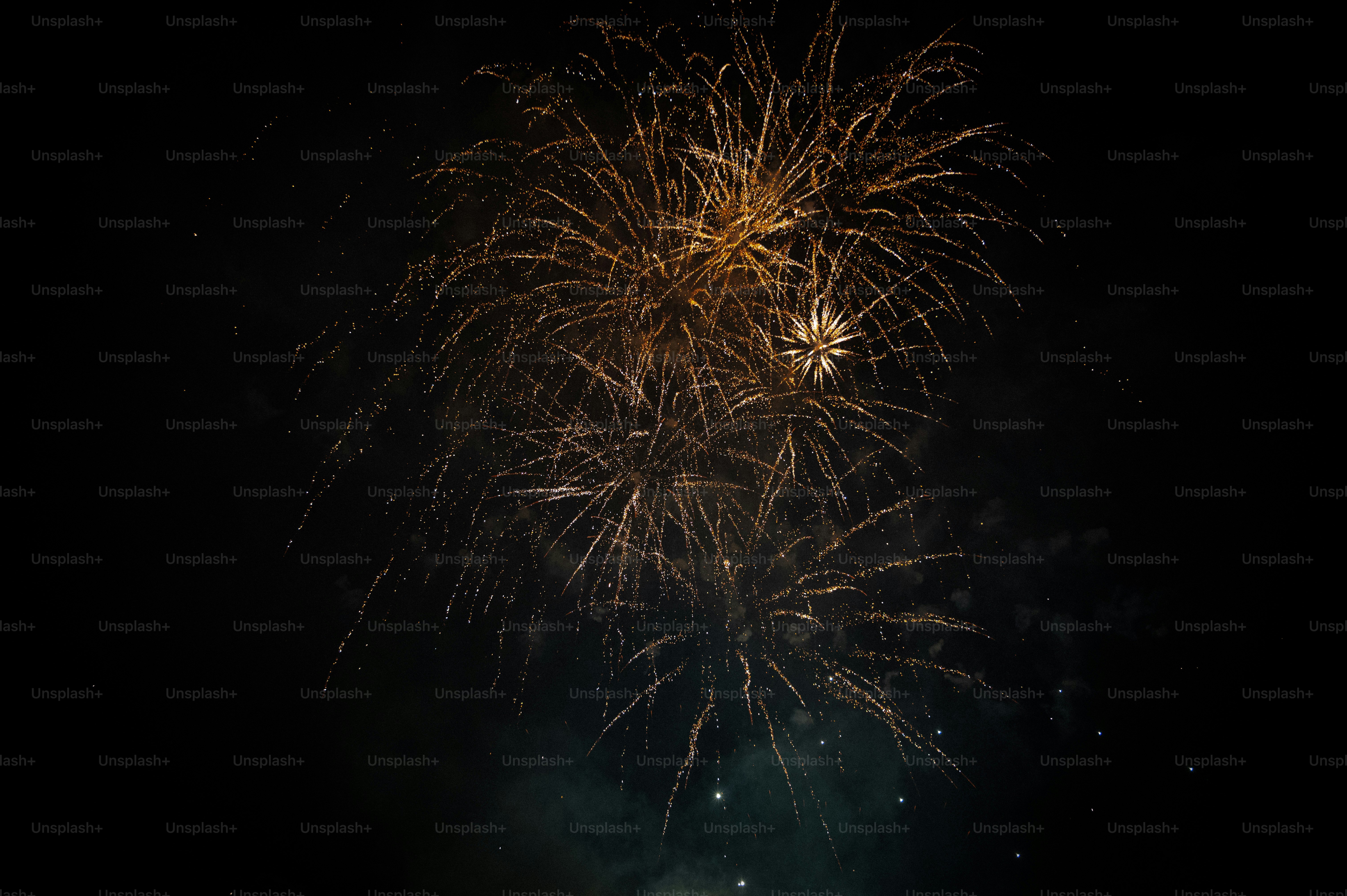 A large fireworks is lit up in the night sky photo – Firework Image on ...