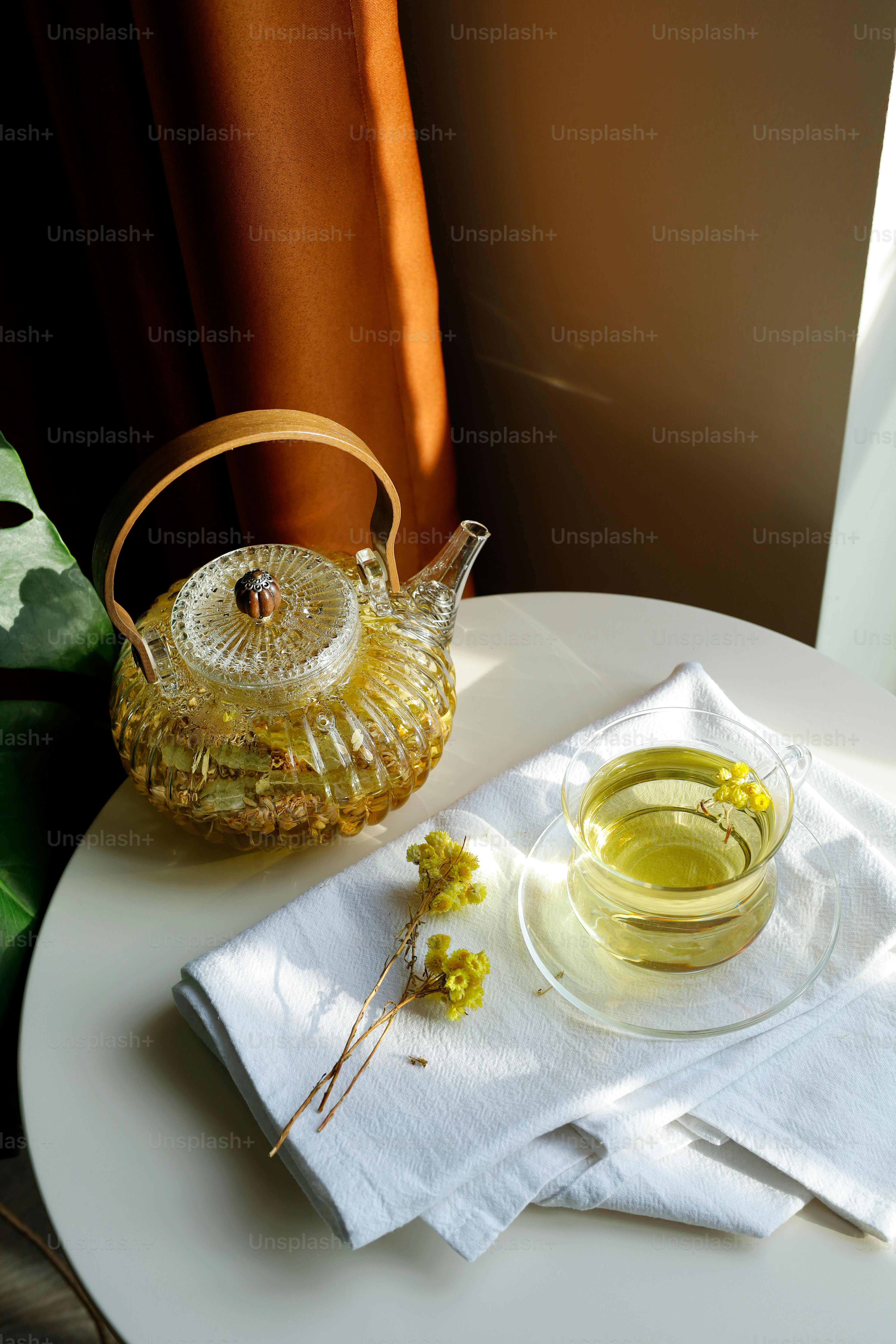 A glass tea pot and a teacup on a white table photo – Tea Image on Unsplash