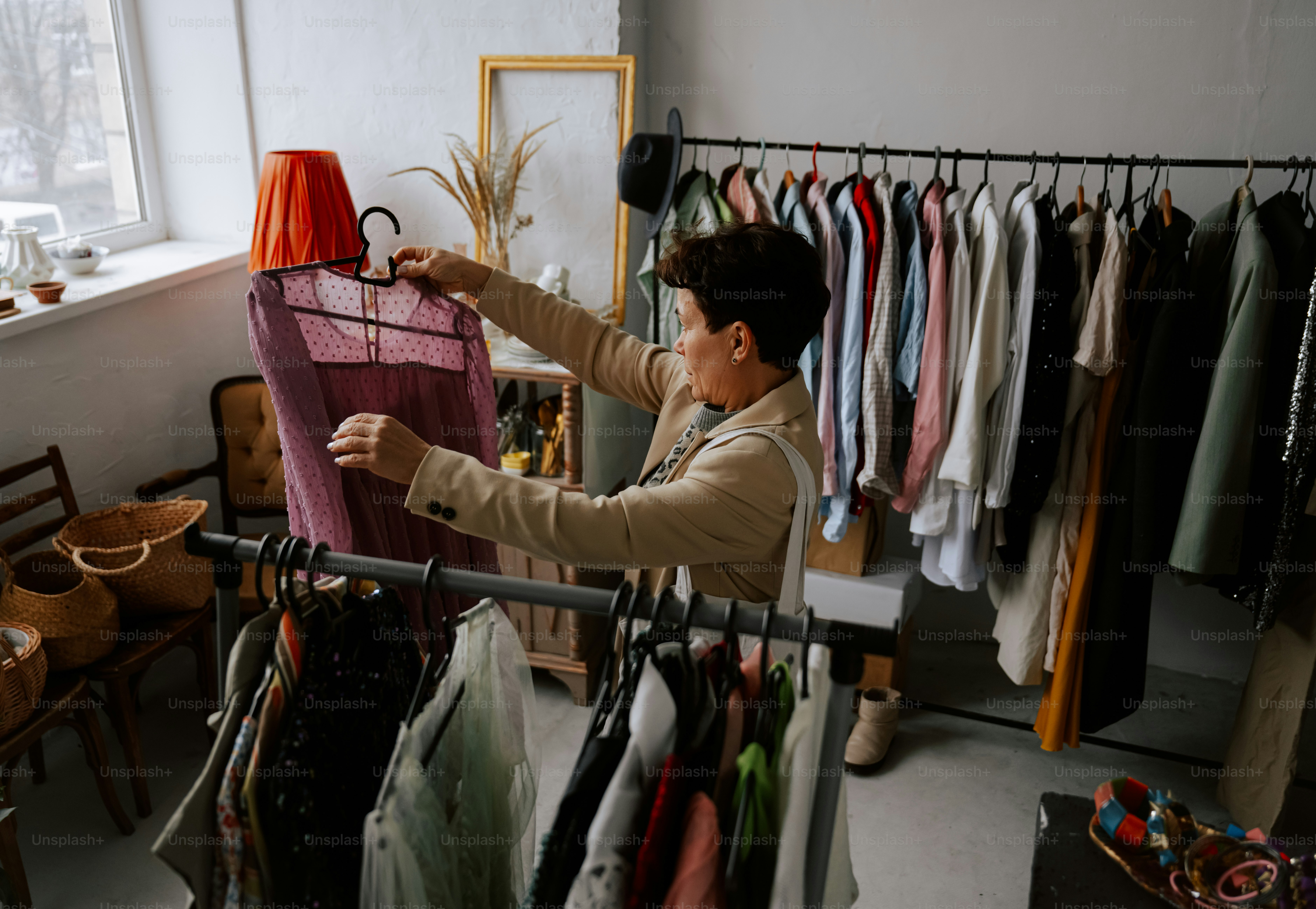 A woman in a room with a rack of clothes photo – Clothes Image on Unsplash