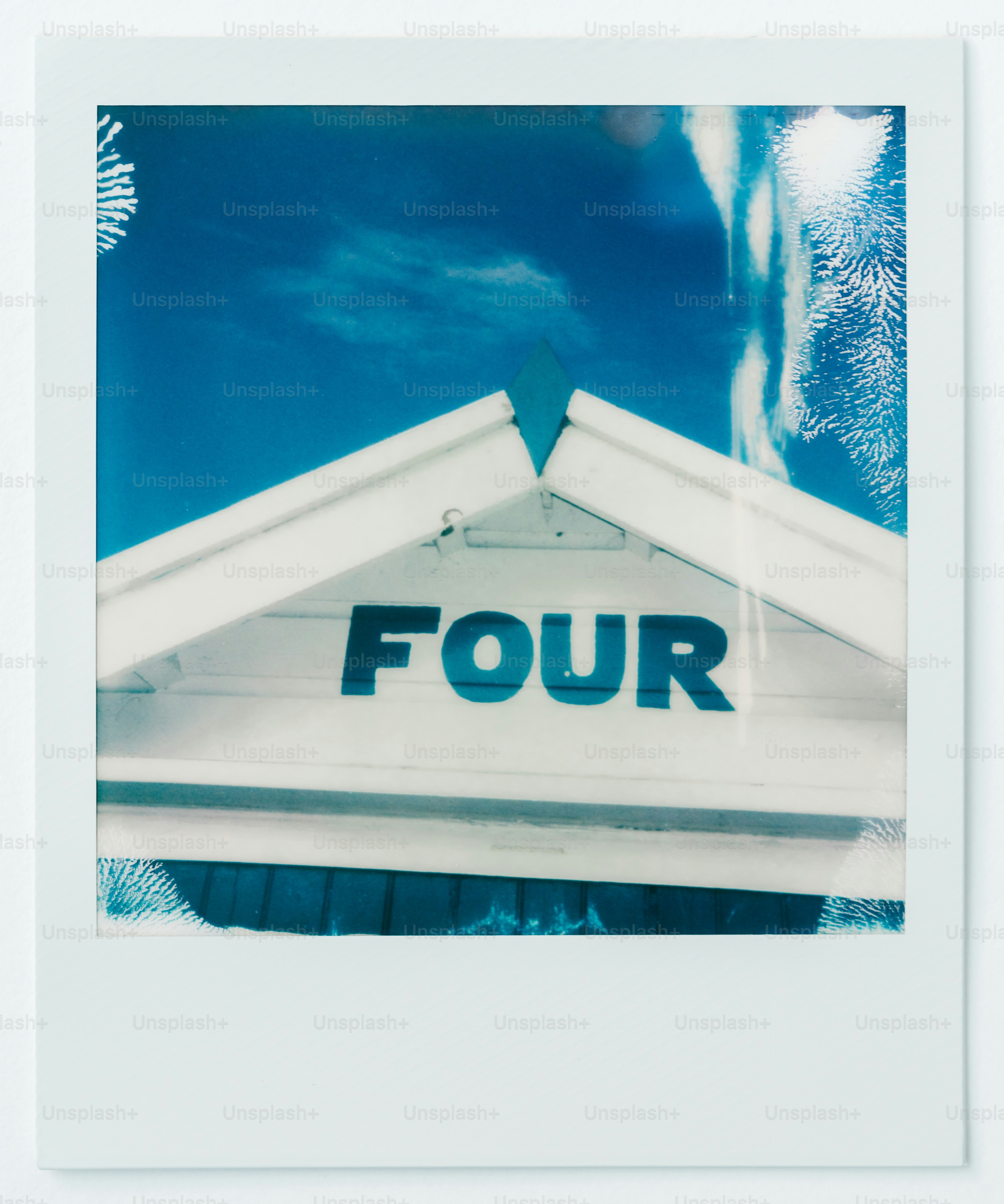 A polaroid photograph of a four sign photo – Beach Image on Unsplash