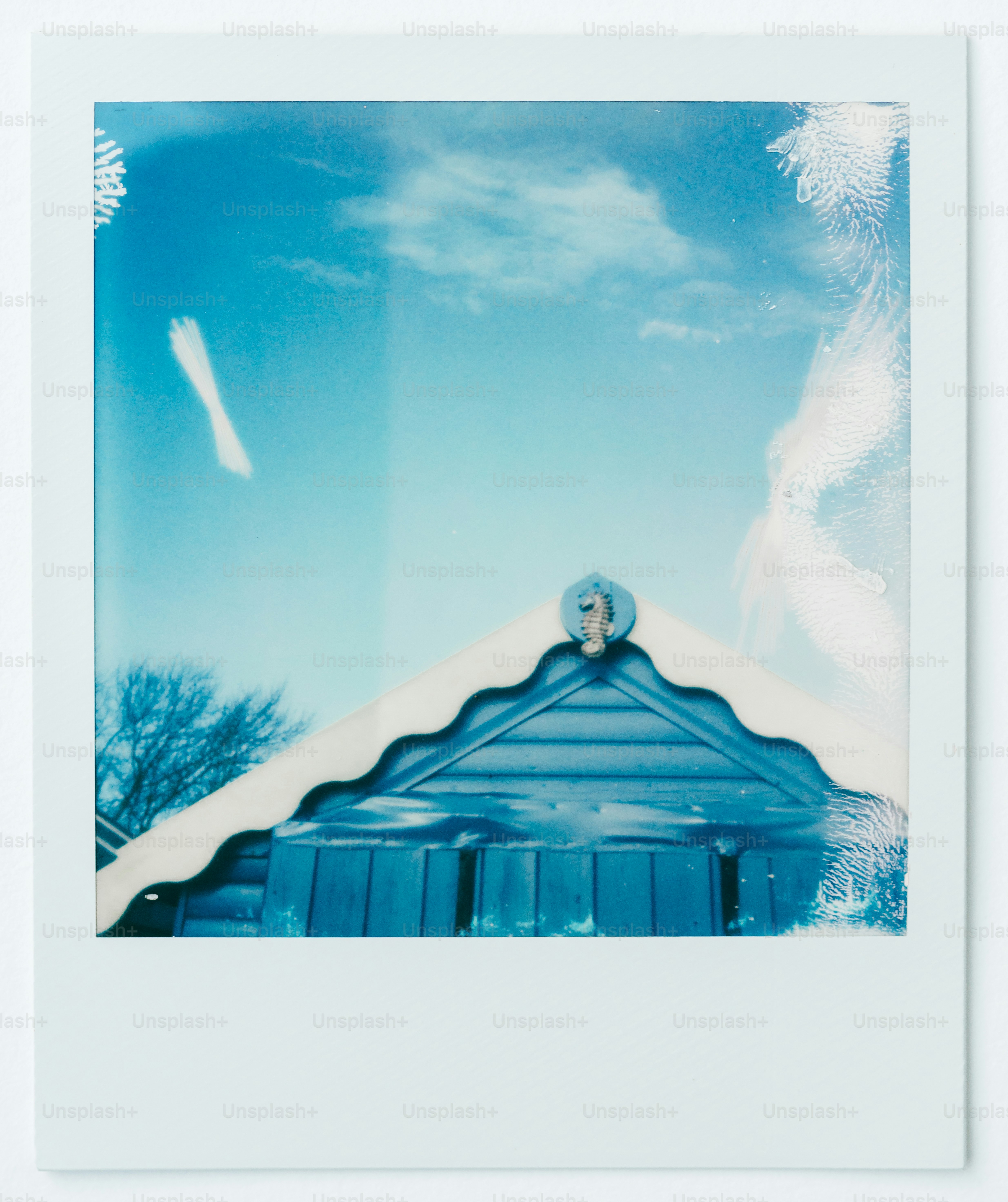A polaroid photograph of a building with a sky background photo ...