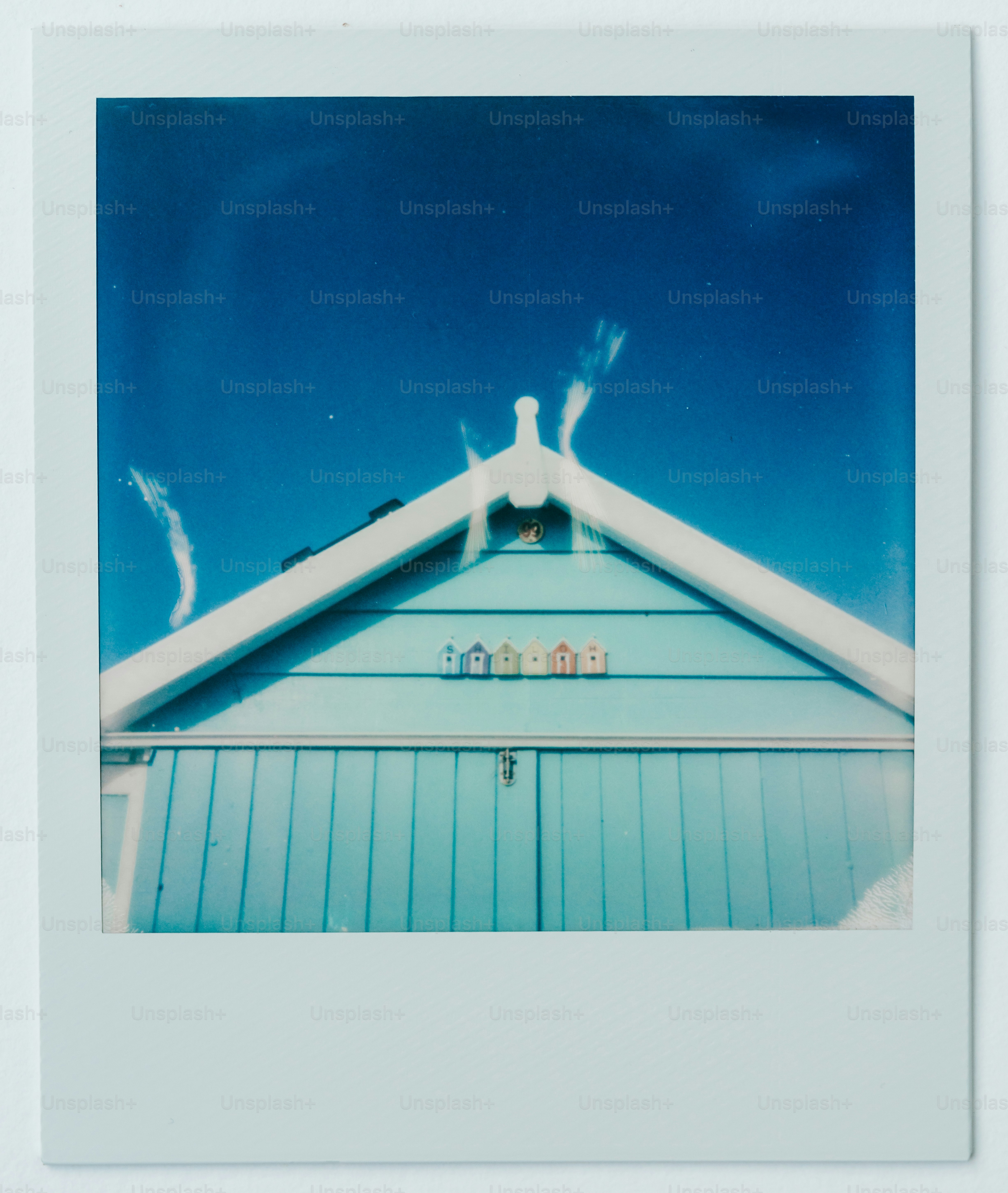 A polaroid photograph of a building with a sky background photo – Image ...