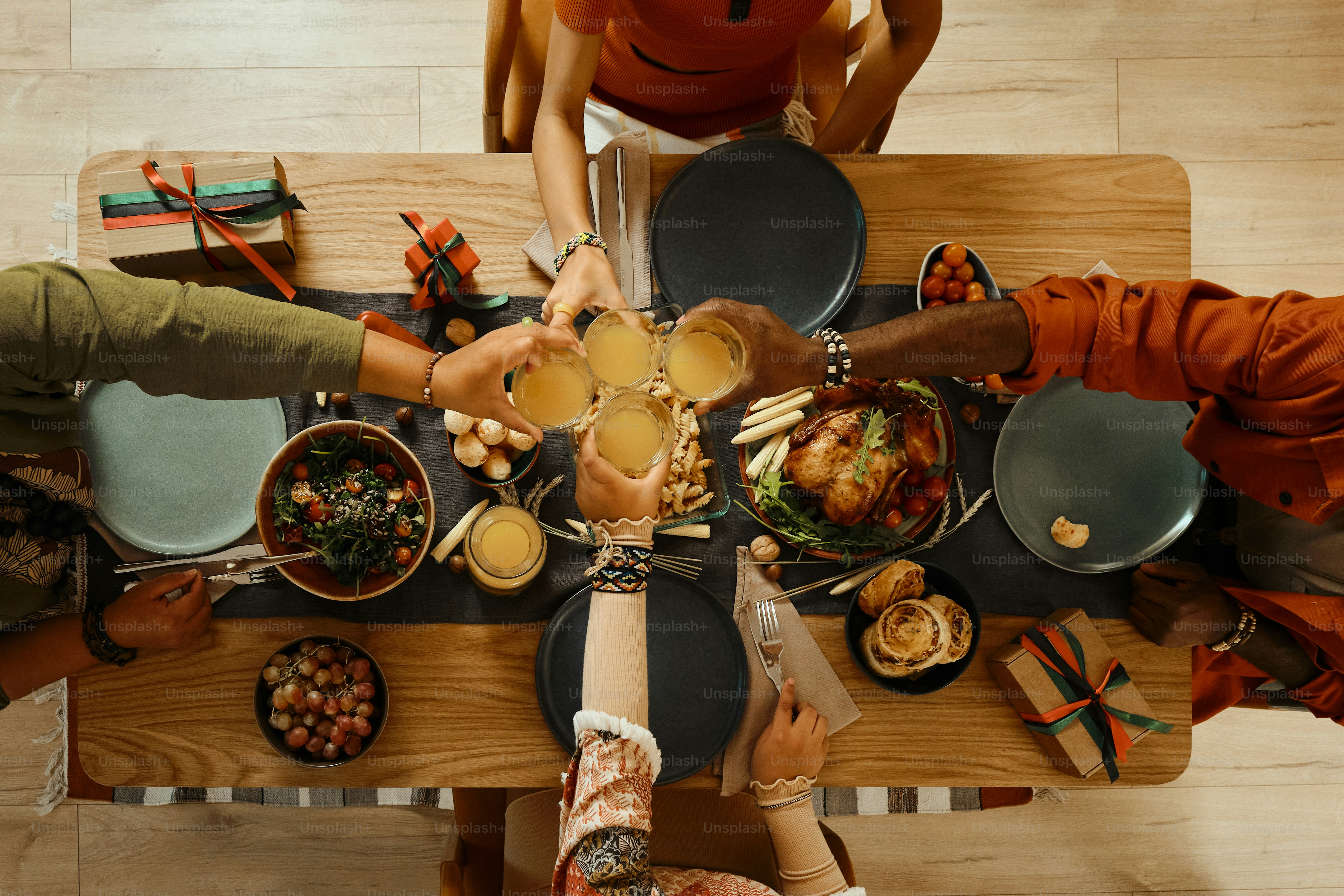 A group of people sitting around a wooden table photo – Family Image on ...