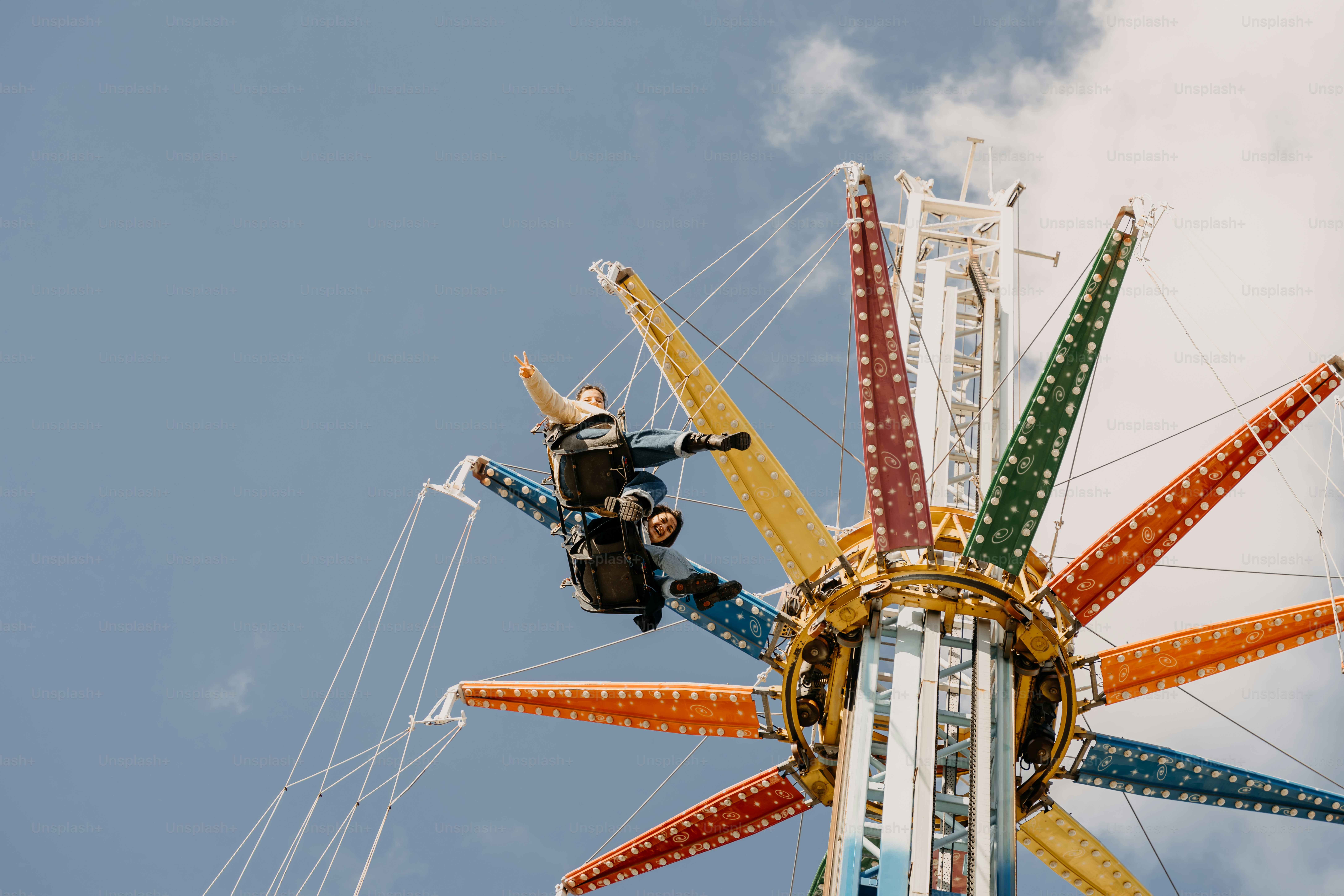 A man riding a carnival ride on top of a ferris wheel photo ...