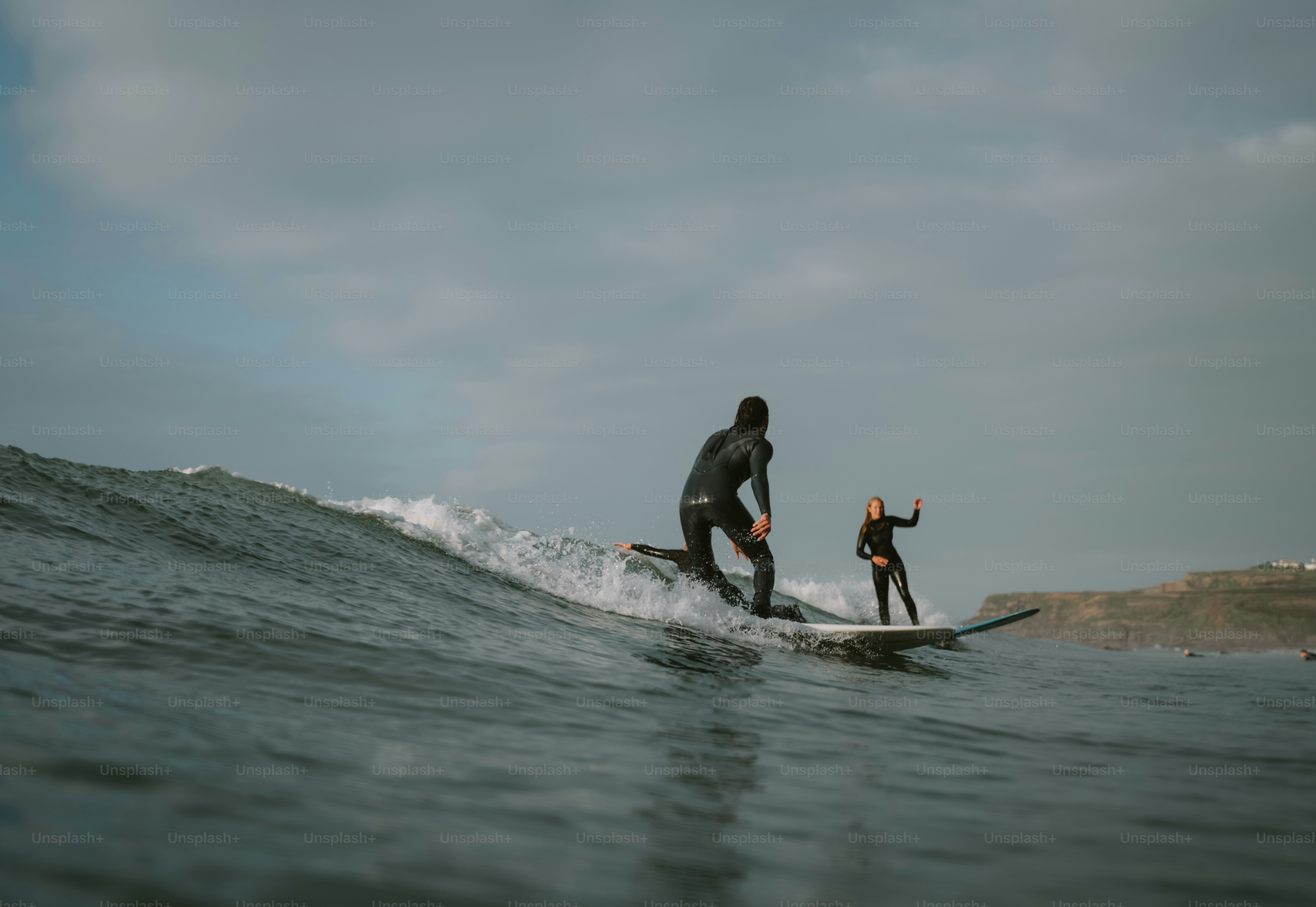 A man riding a wave on top of a surfboard photo – Surfing Image on Unsplash